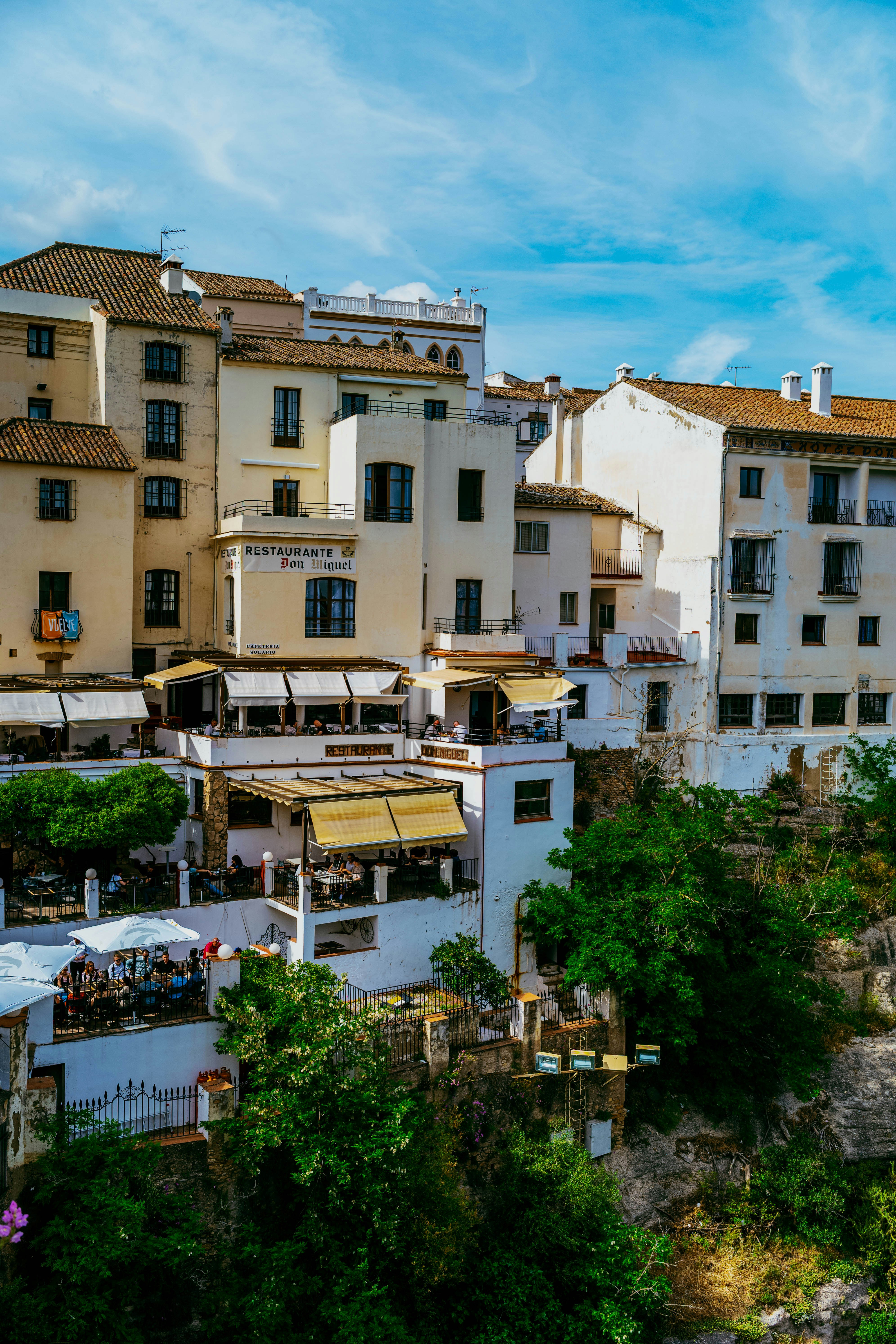 Cliffside Village Café Terrace Under a Blue Sky