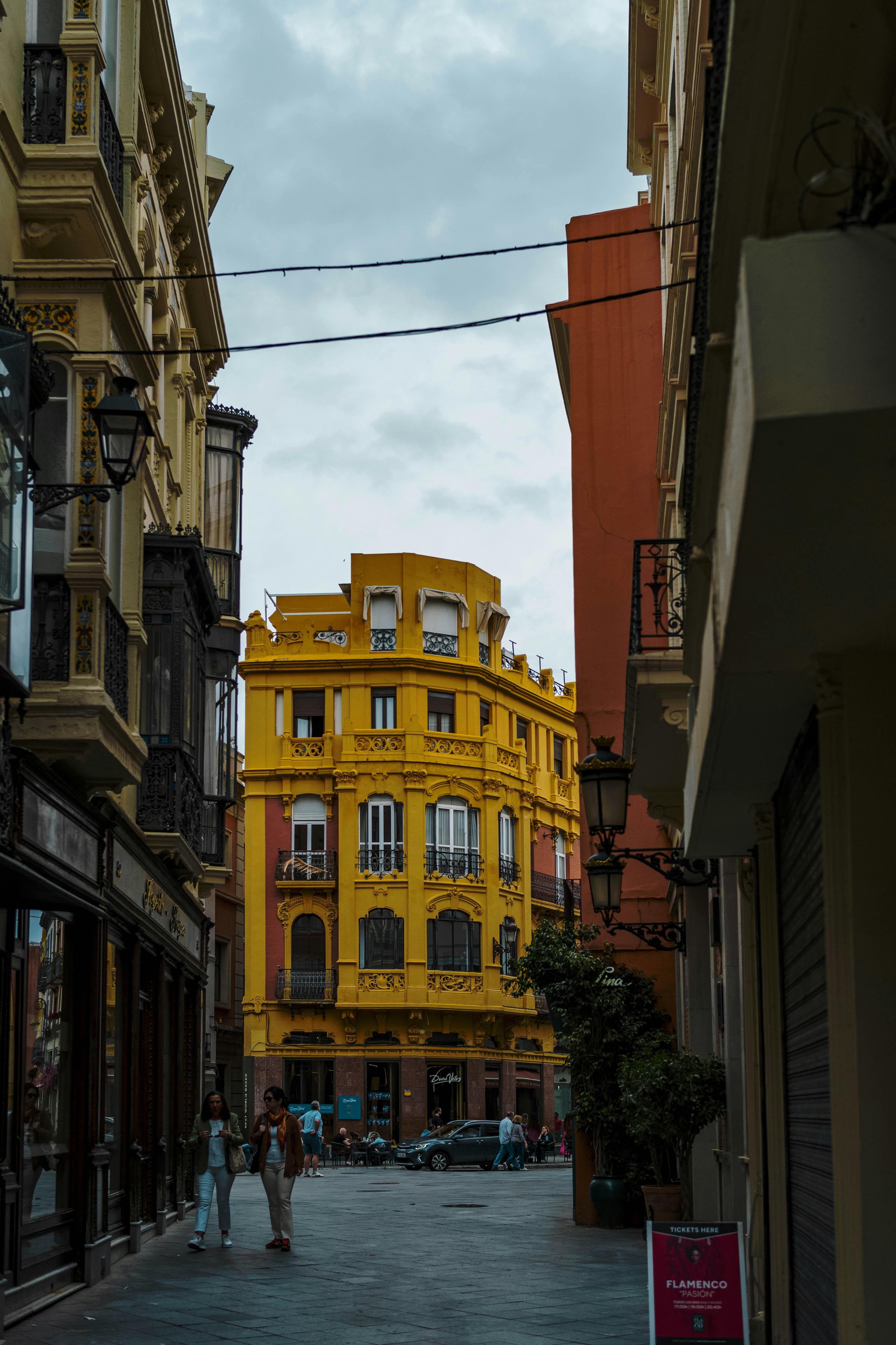 Sunlit Yellow Facade: A Quiet Calle in the City
