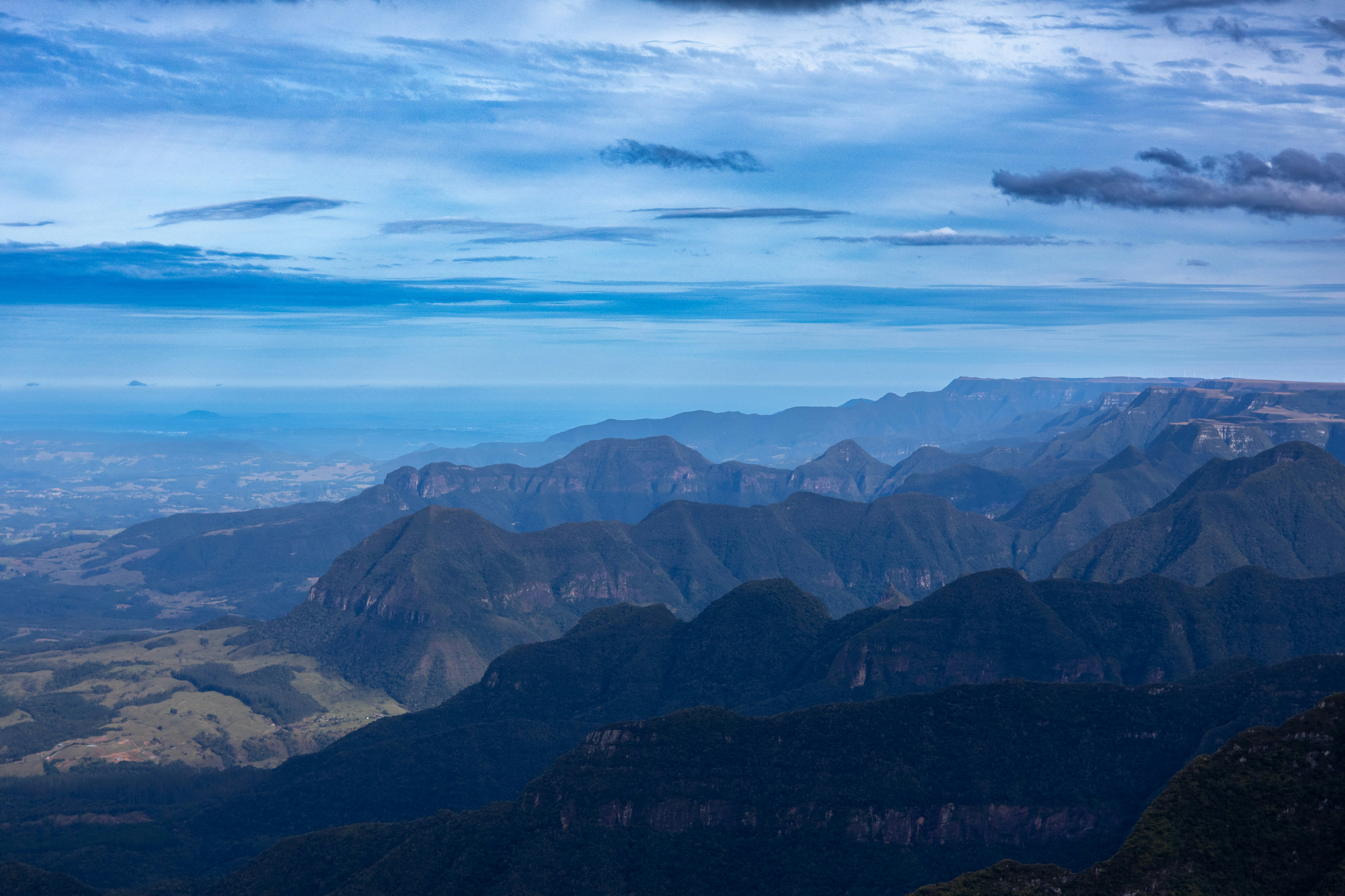 Aerial Serenade: Rugged Ridges Under a Calm Sky