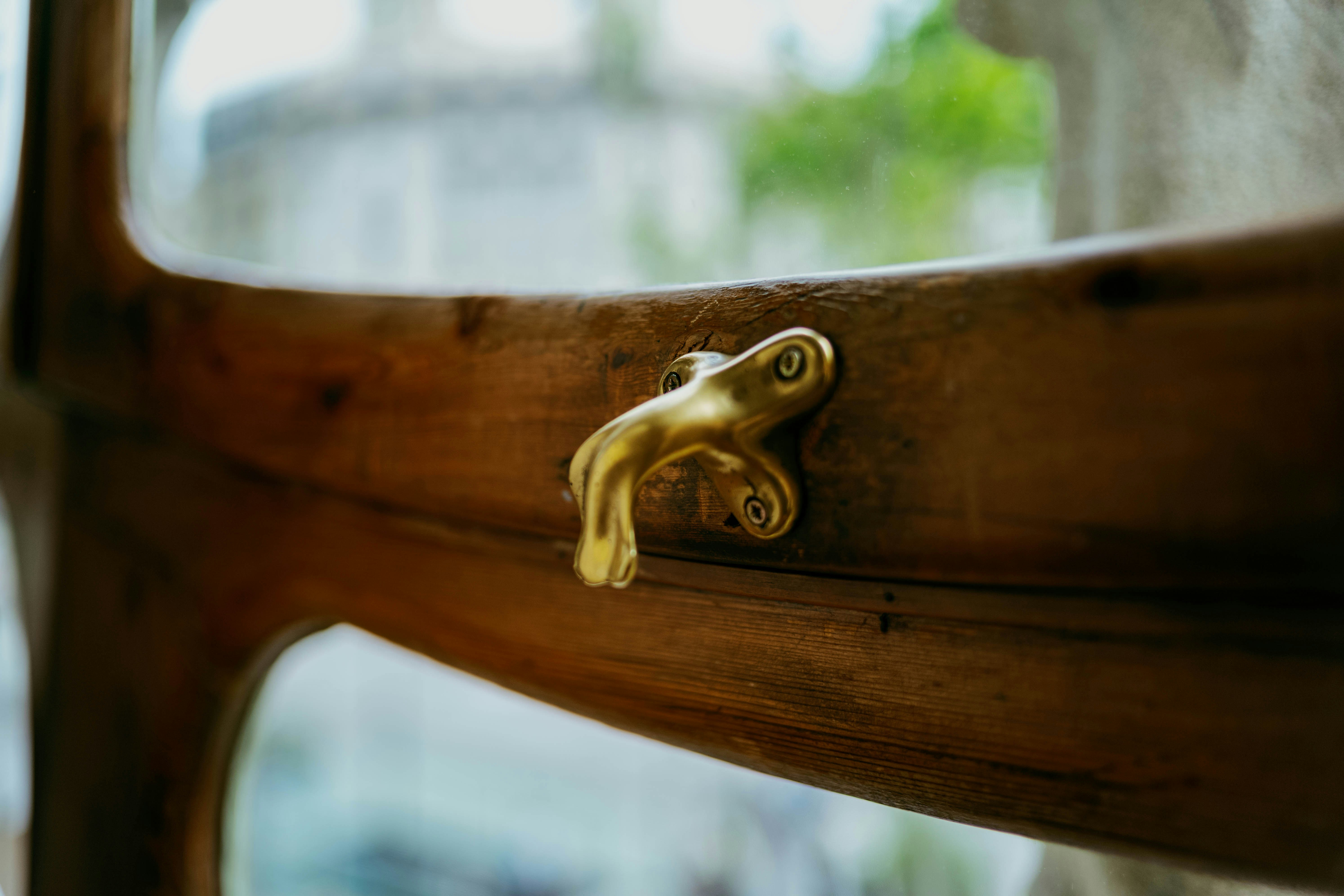 A Brass Latch on Weathered Wood: A Quiet Window of Focus