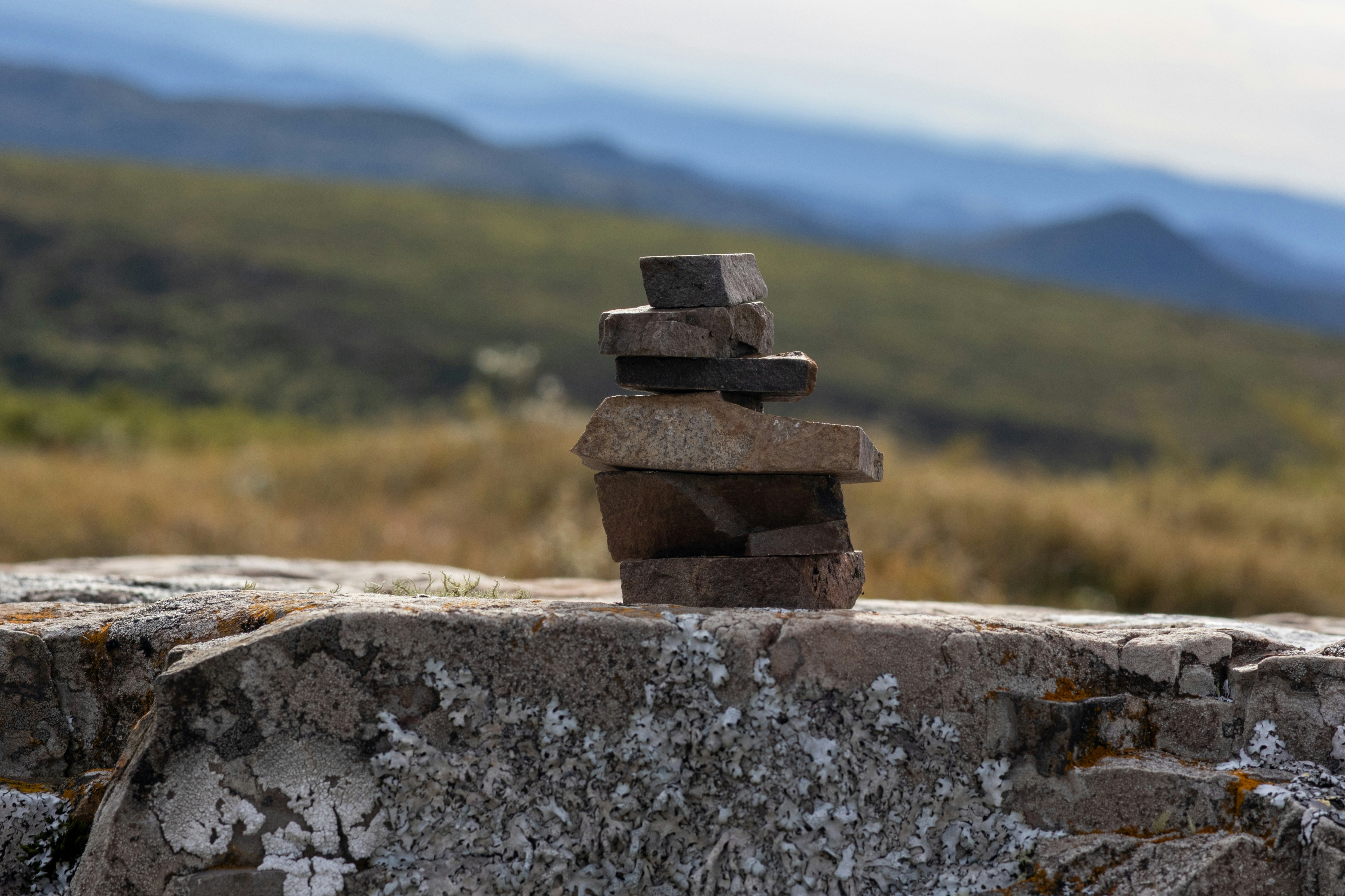 Stone Stack on Weathered Wall in Open Moorland