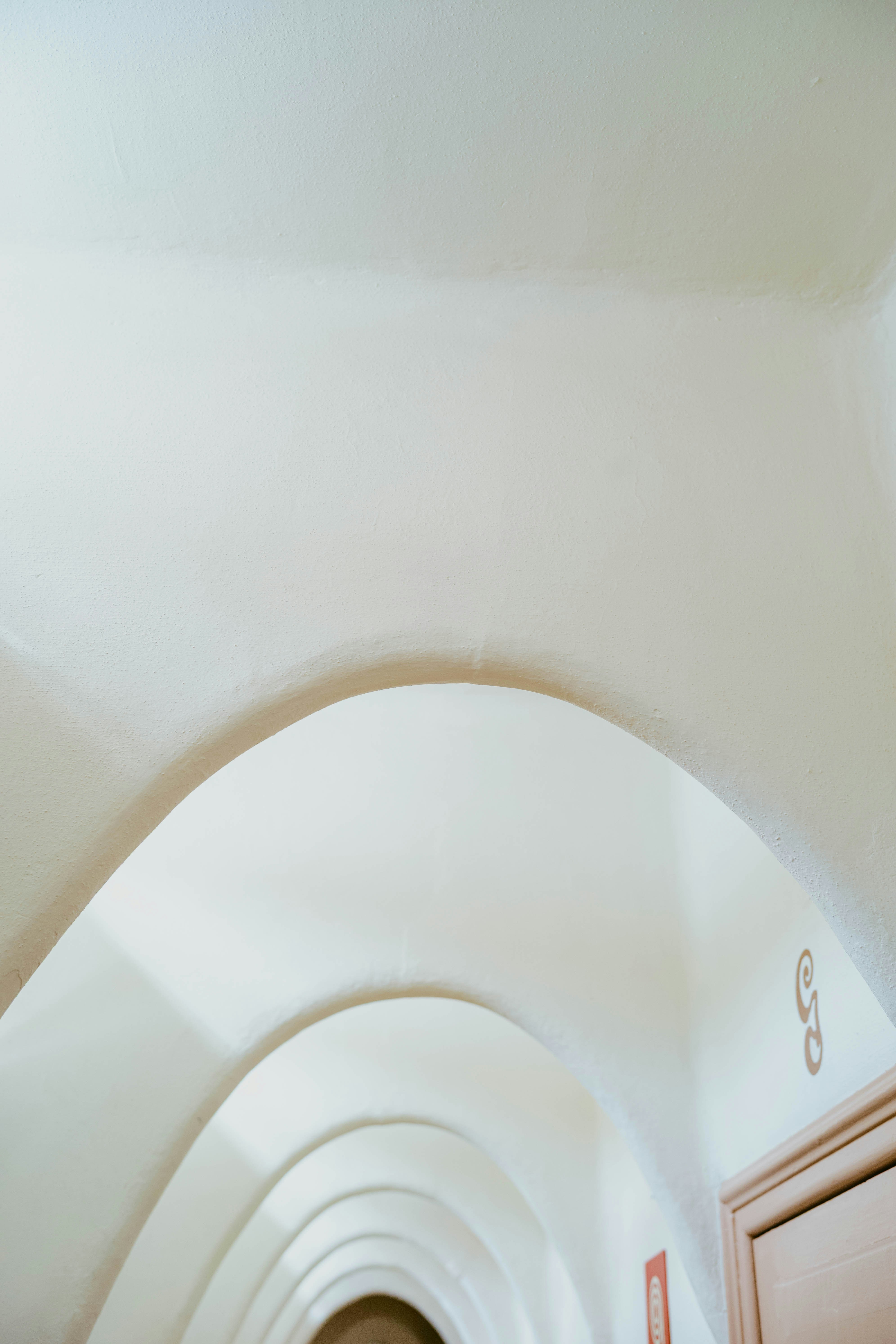 Archway Corridor: Repeating Curves in Soft Light