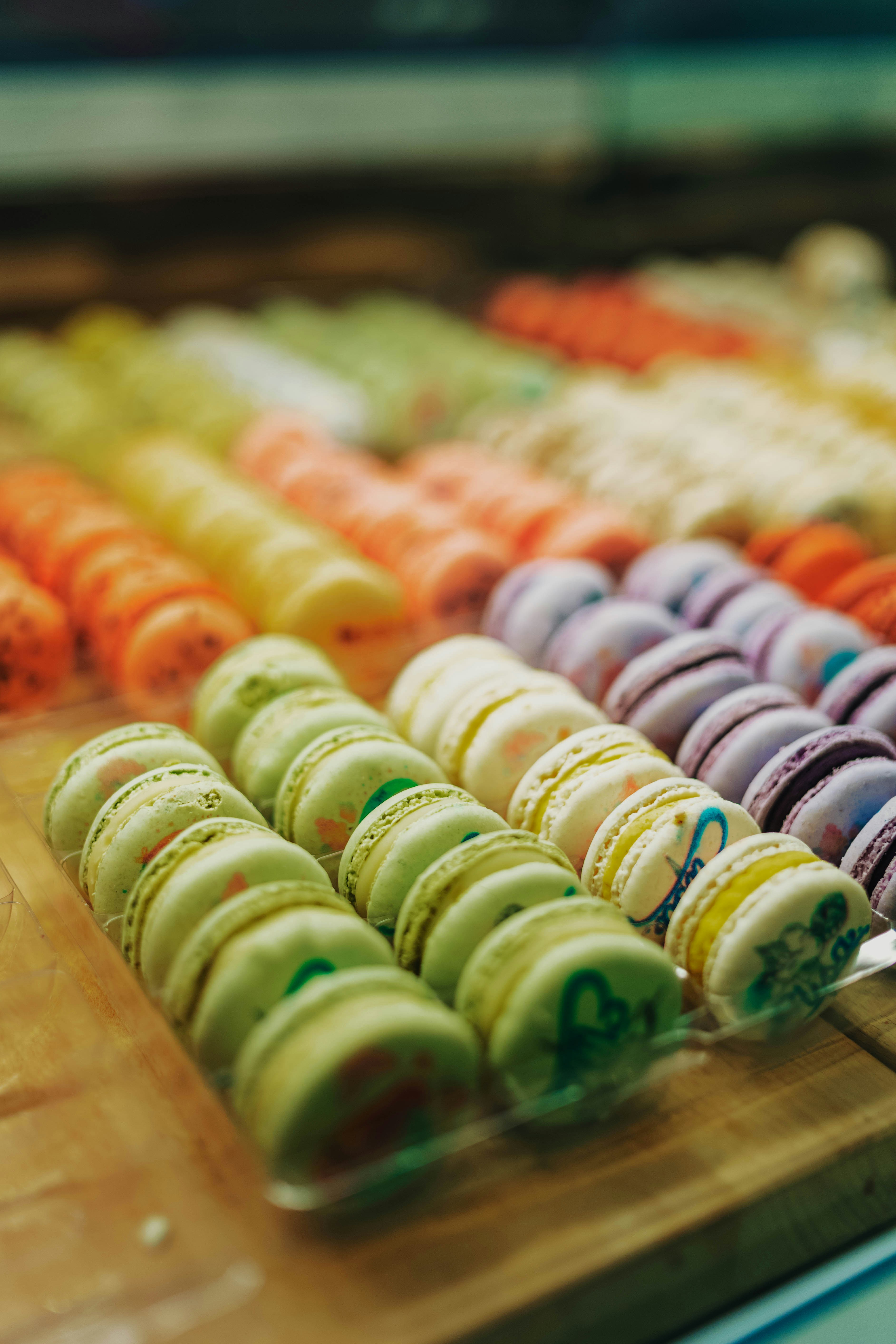 Rows of Pastel Macarons at a Front Counter