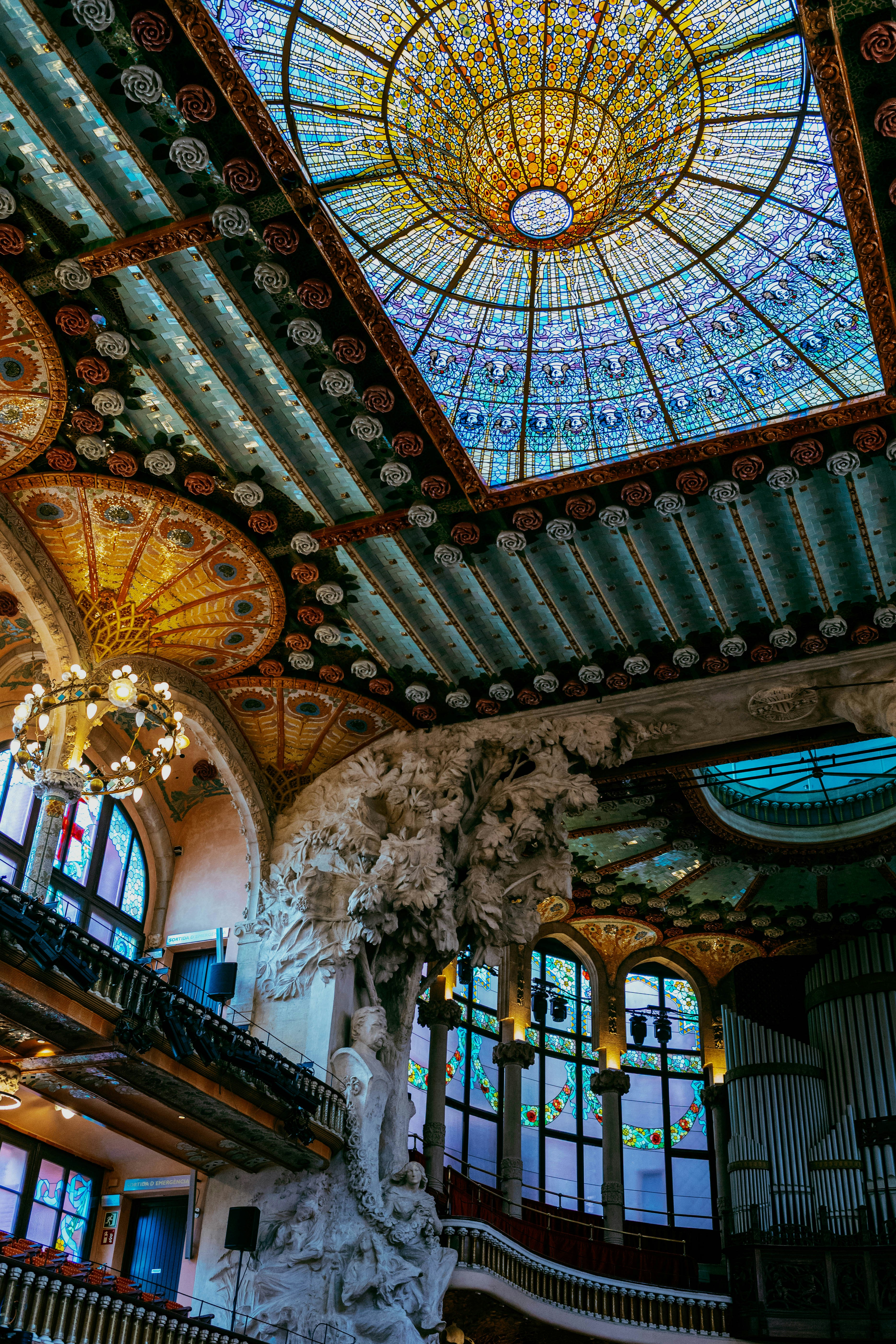 Stained Glass Dome and Ornate Interior of a Historic Hall