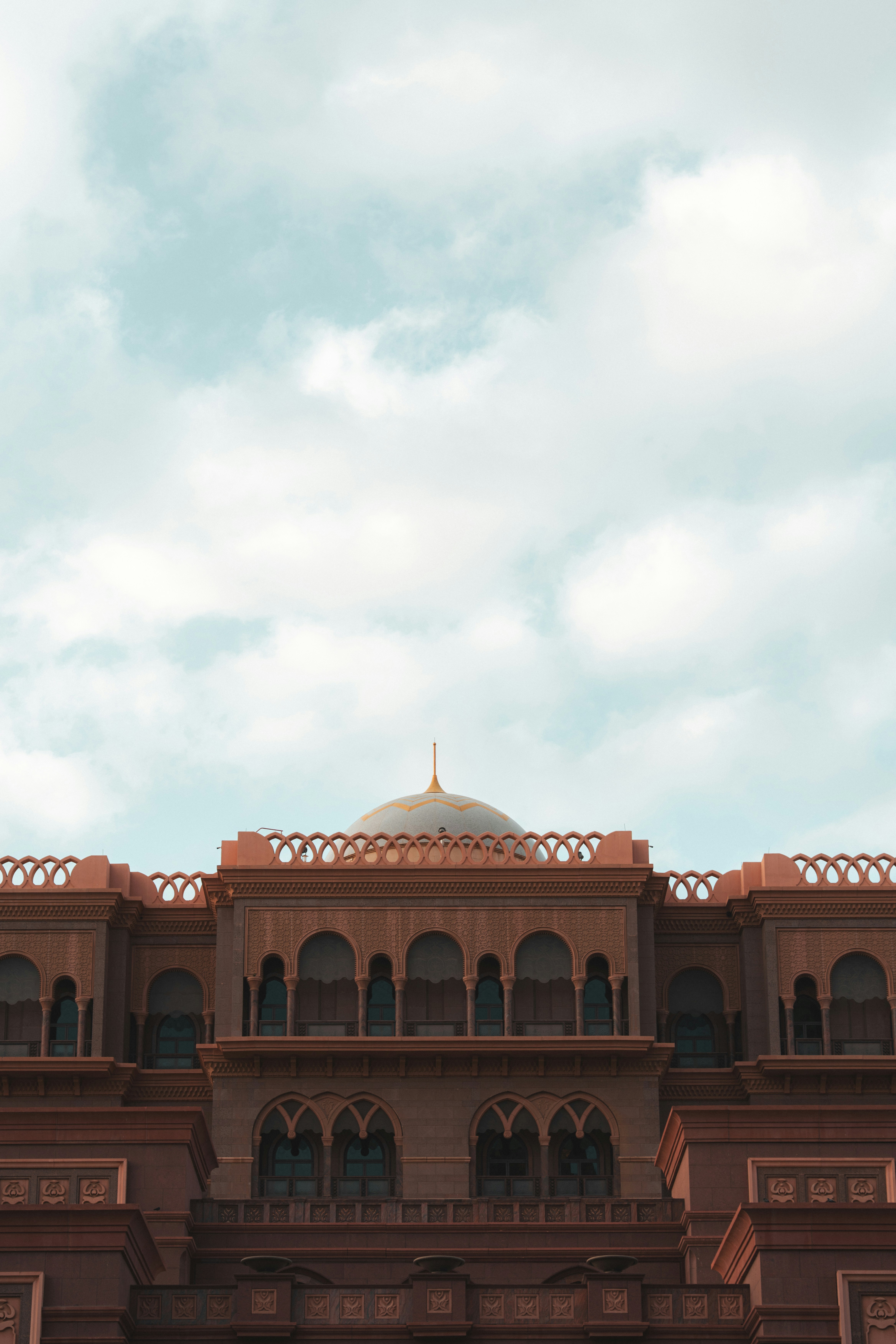 Rising Dome and Red Facade: A Monolithic Architectural Presence