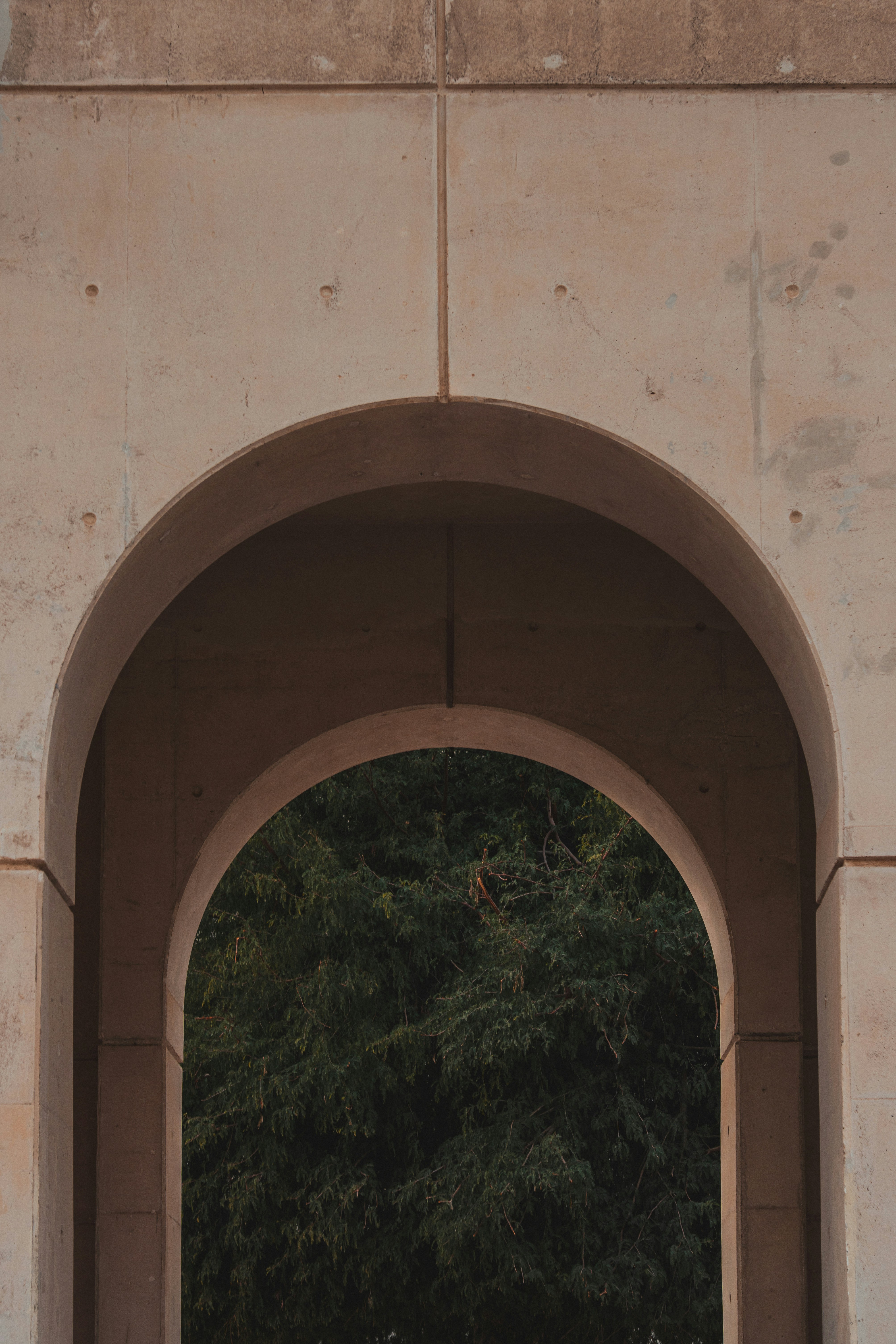 Stone Archway Framing a Lush Green View