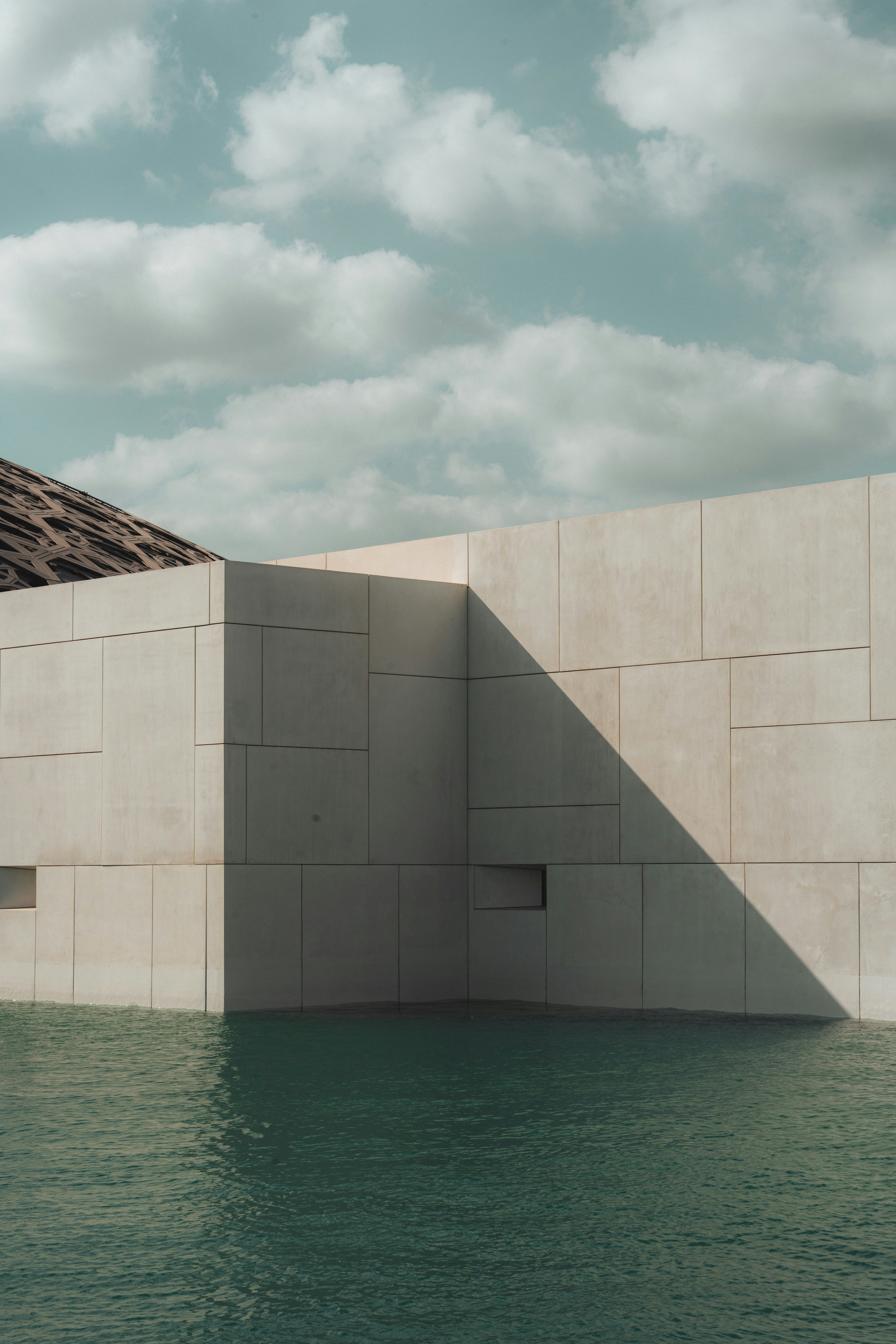 Architectural Geometry: Shadows on Concrete Facade by the Water