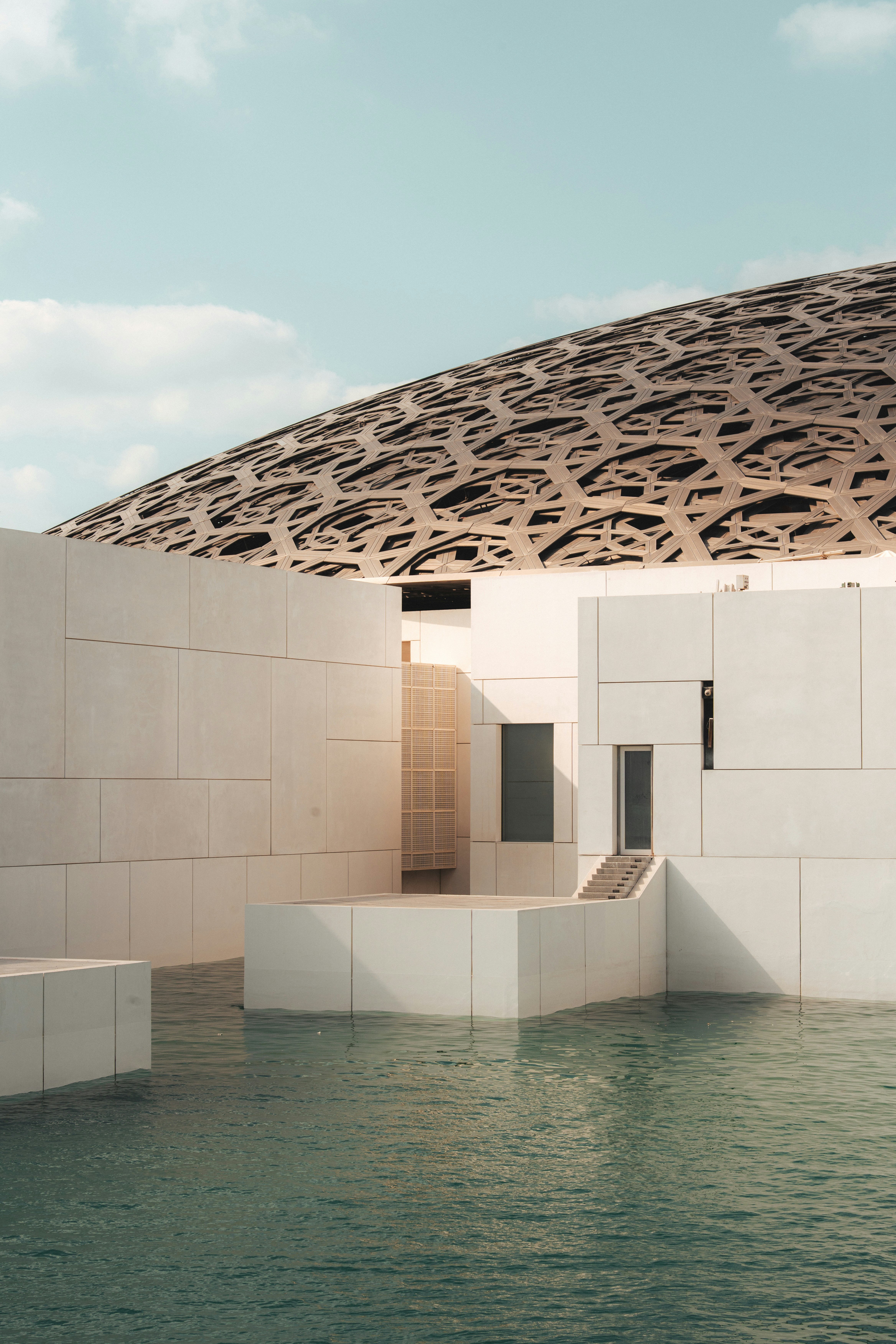 Geometric Dome Over White Terraces by a Calm Aquatic Canvas