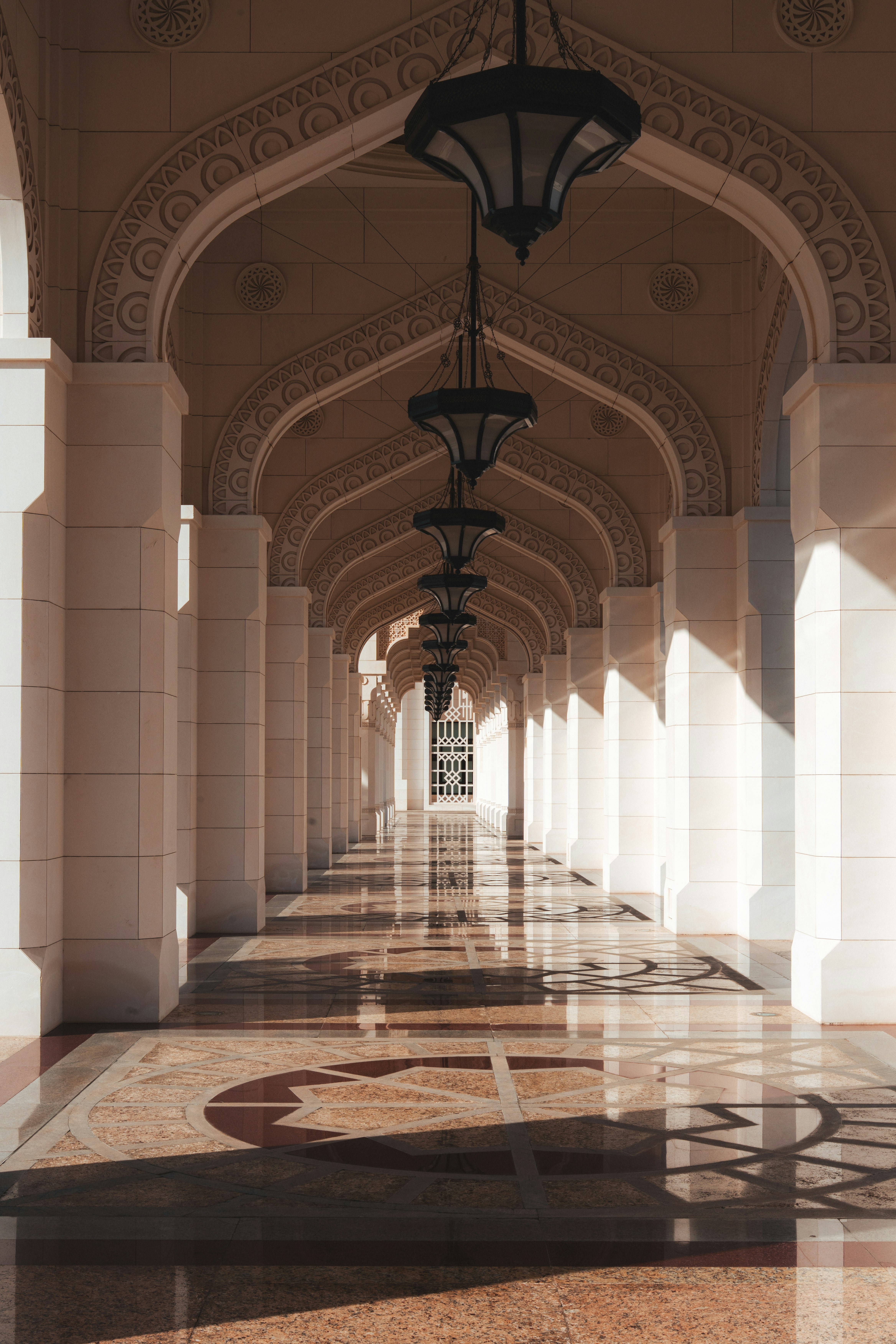 Symmetrical Walkway: Arches and Lanterns Recede into Light