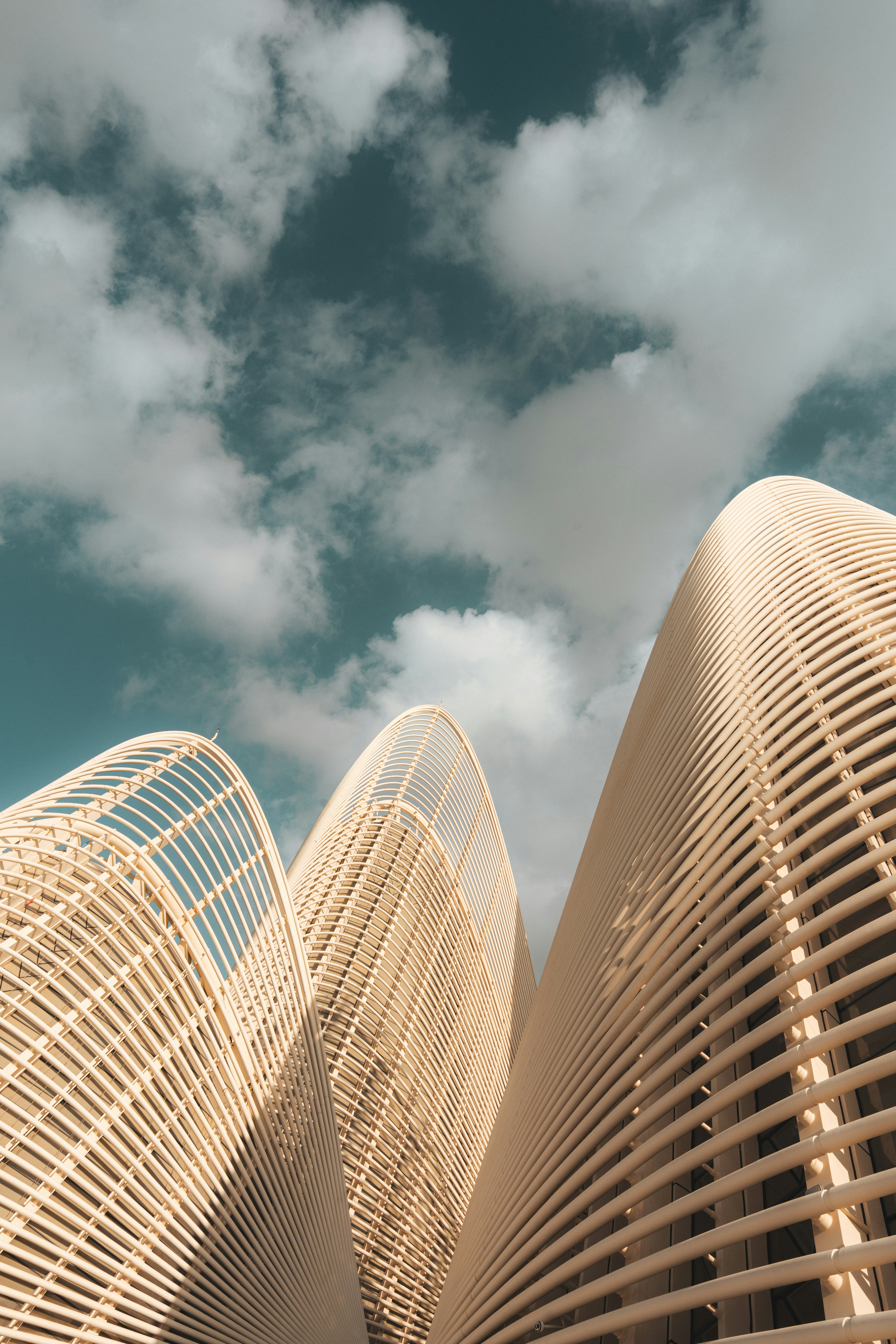 Curved Facades Converge Under a Sky of Soft Clouds