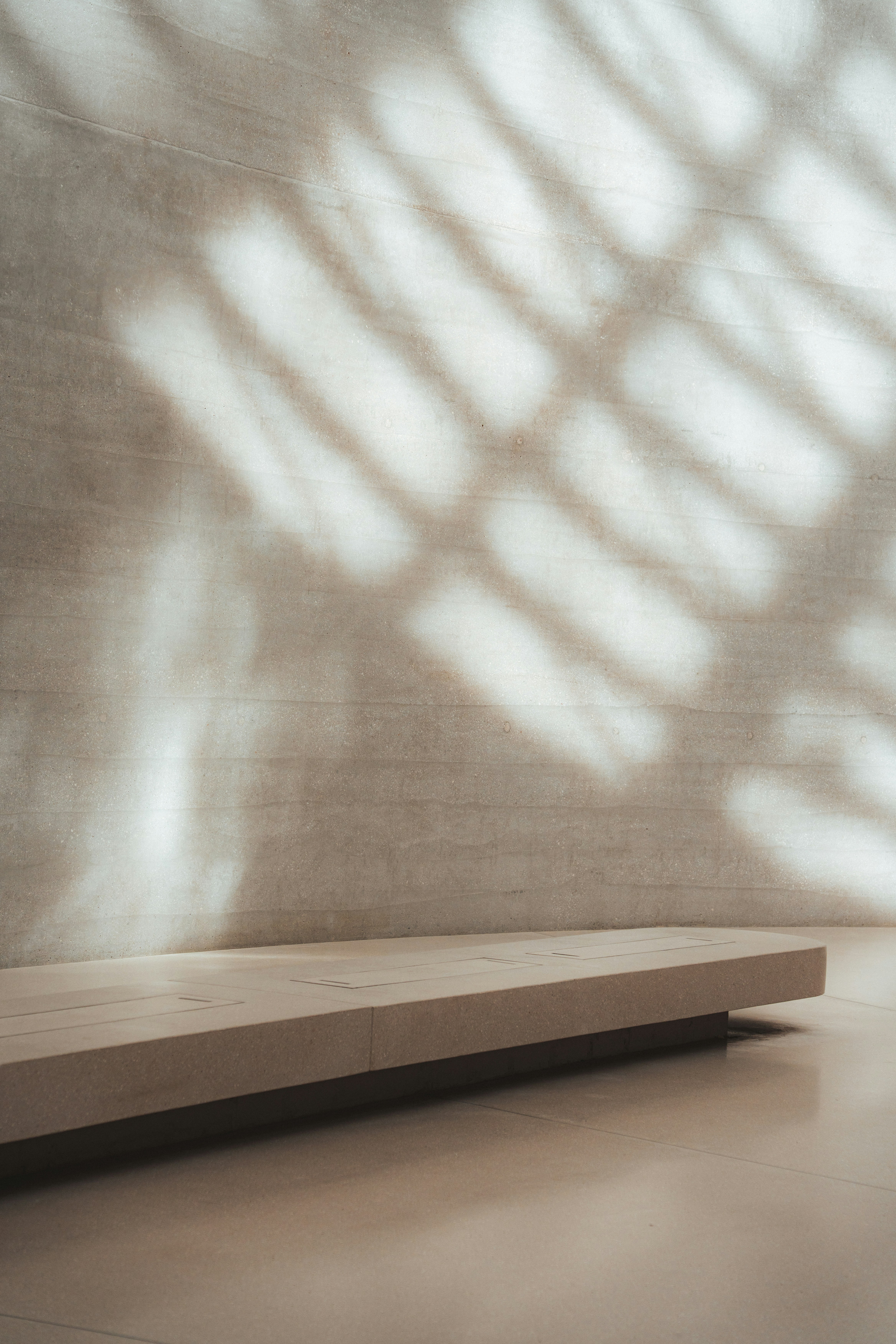 Shadowed Geometry on a Quiet Concrete Wall