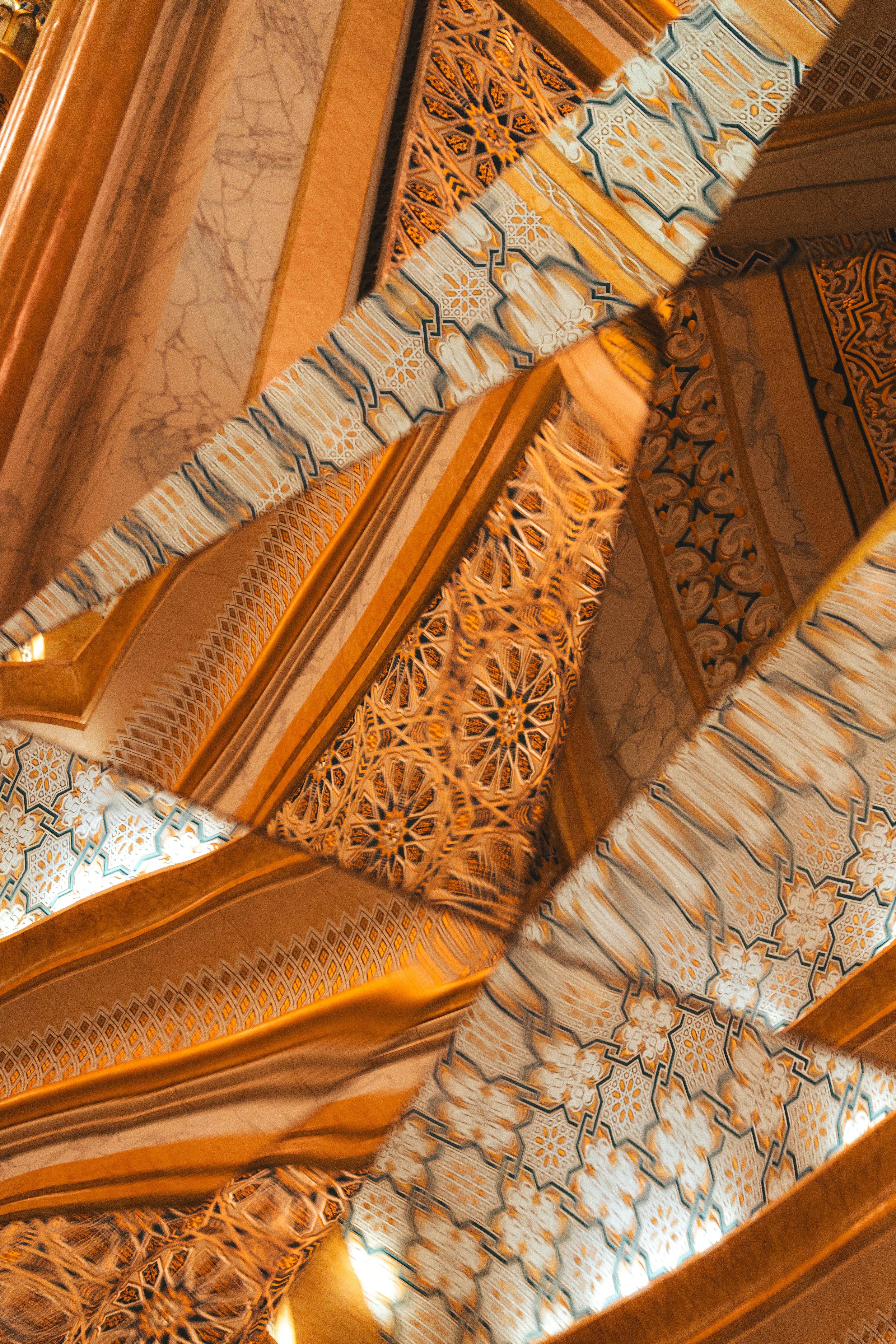 Intricate Golden Stairwork: Tile Patterns on a Marble Backdrop