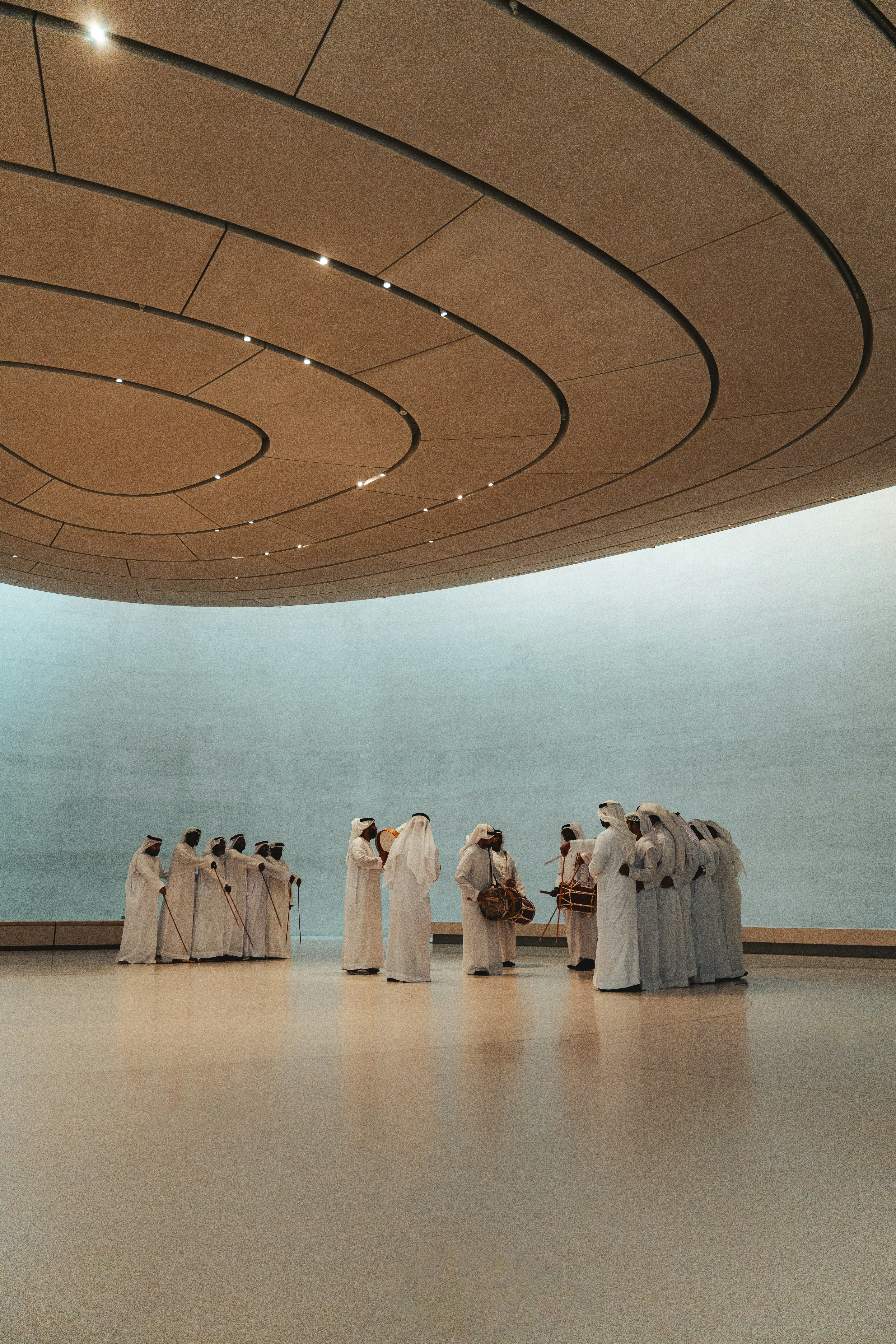 A Quiet Assembly Under an Oval Atrium