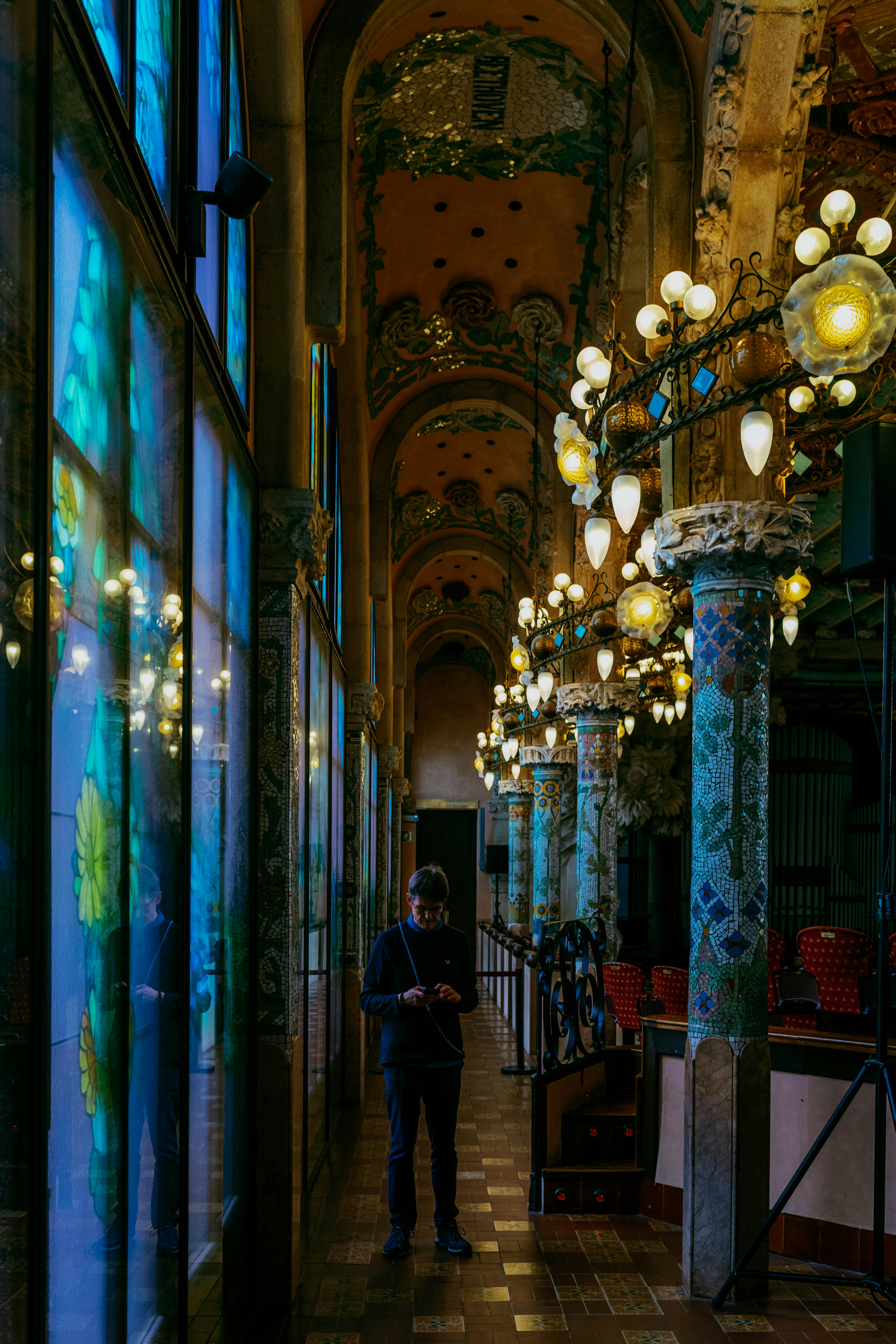 Luminous Arcades: A lone figure under ornate arches