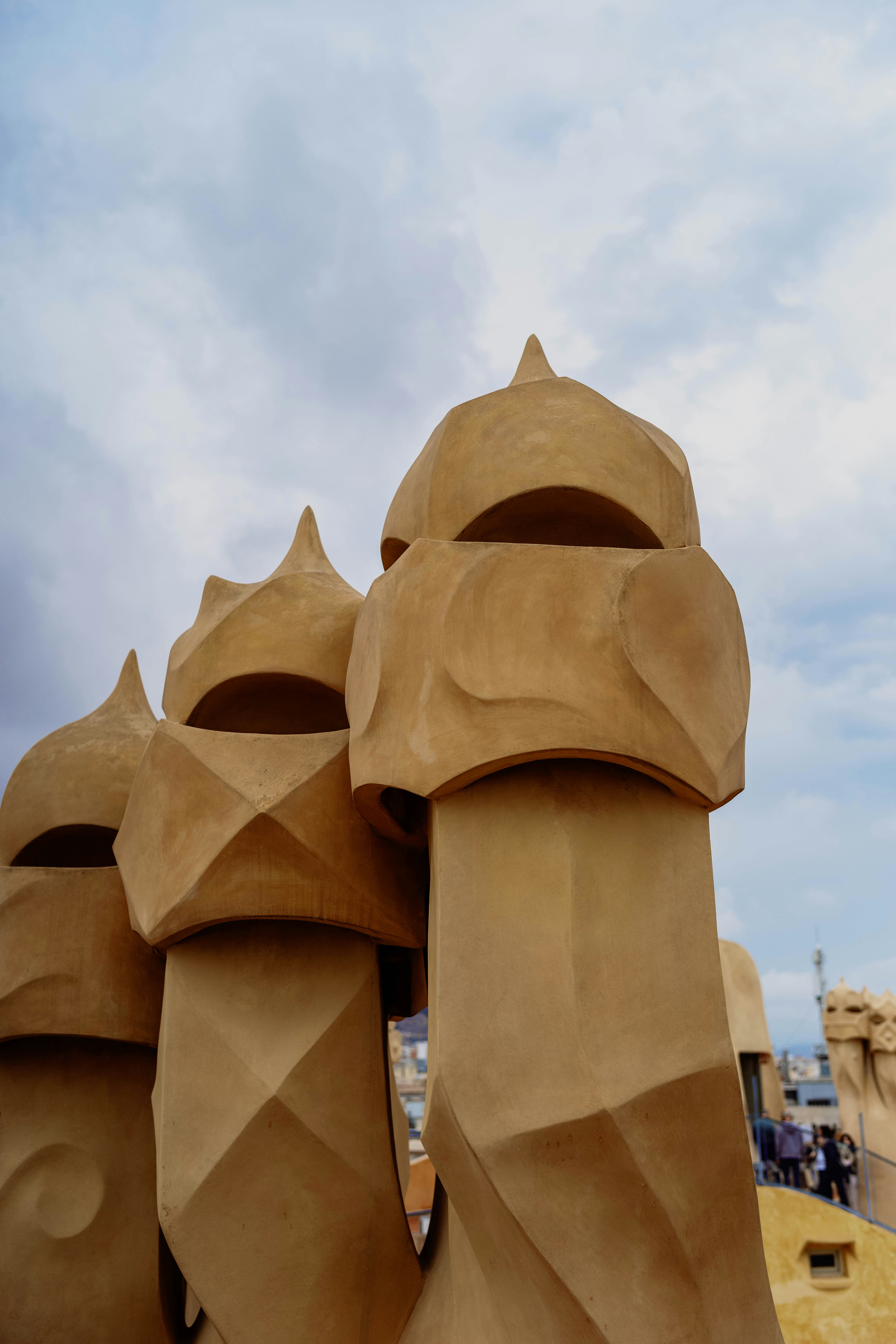 Stone Chimneys of the Rooftop Gothic: Chimera-like Turrets Against a Blue Sky