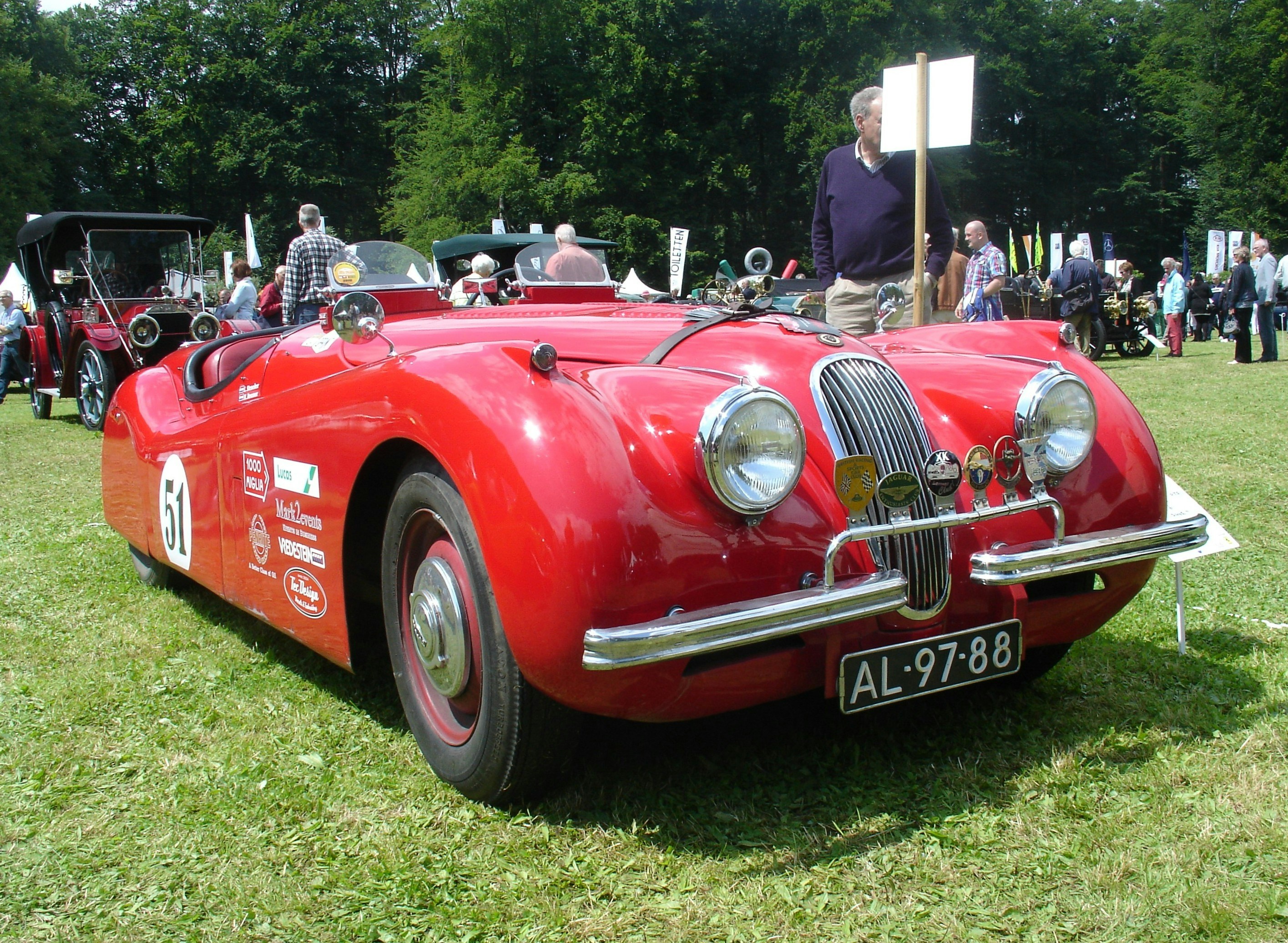 Red Classic: A gleaming vintage racer on a sunlit show field
