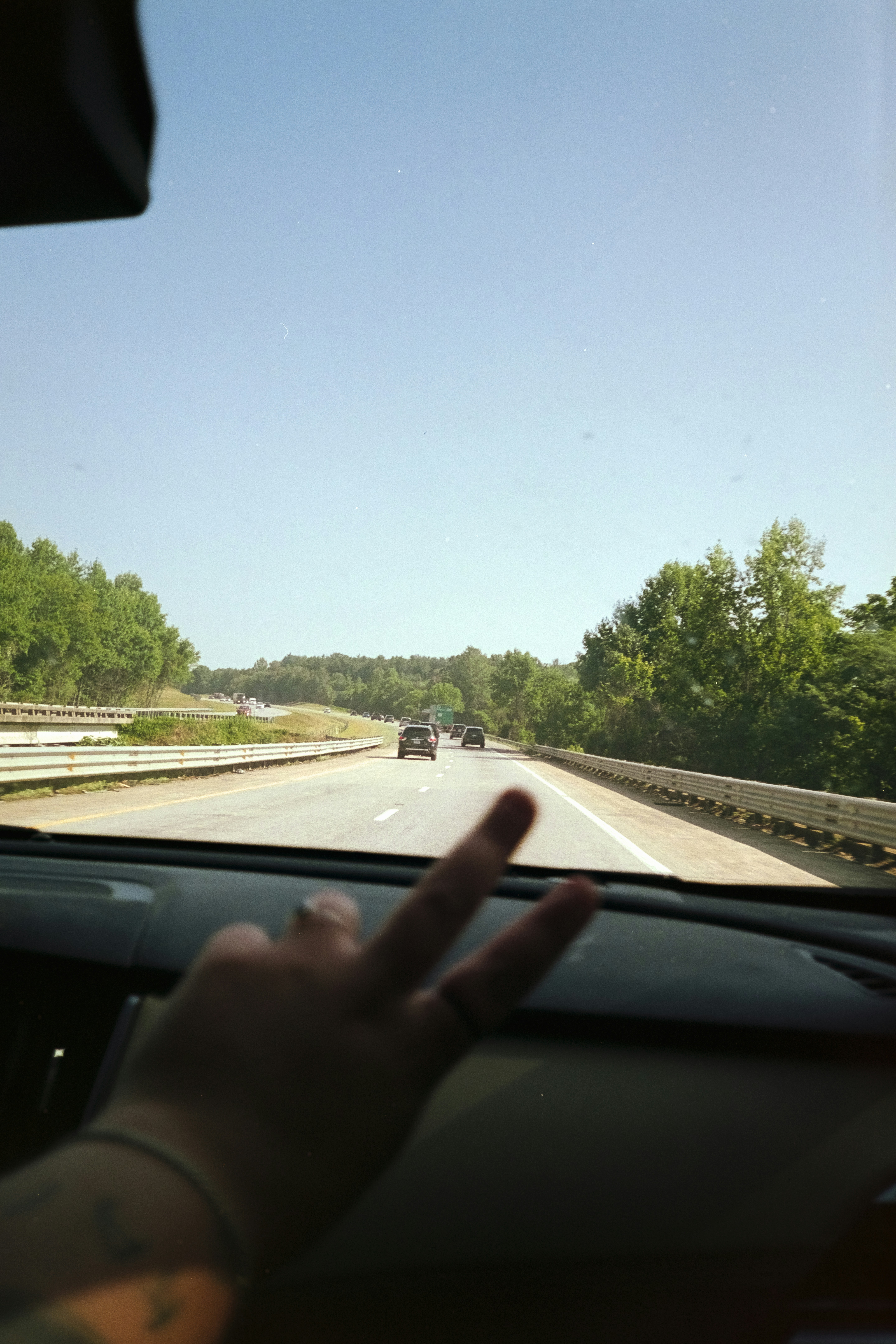Mirthful Road Trip: Hand Peace Over the Moving Horizon