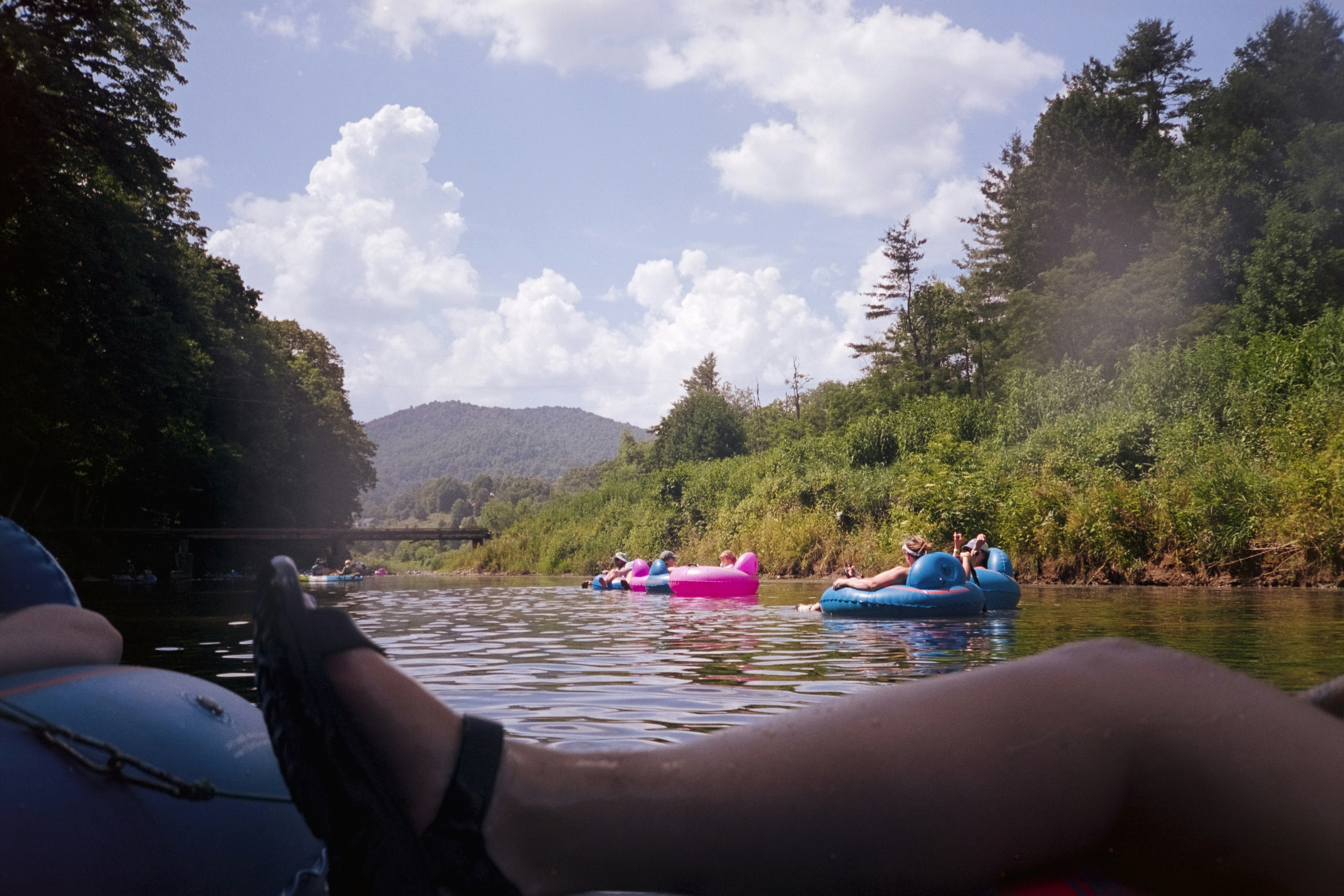 Tubers floating down a scenic river