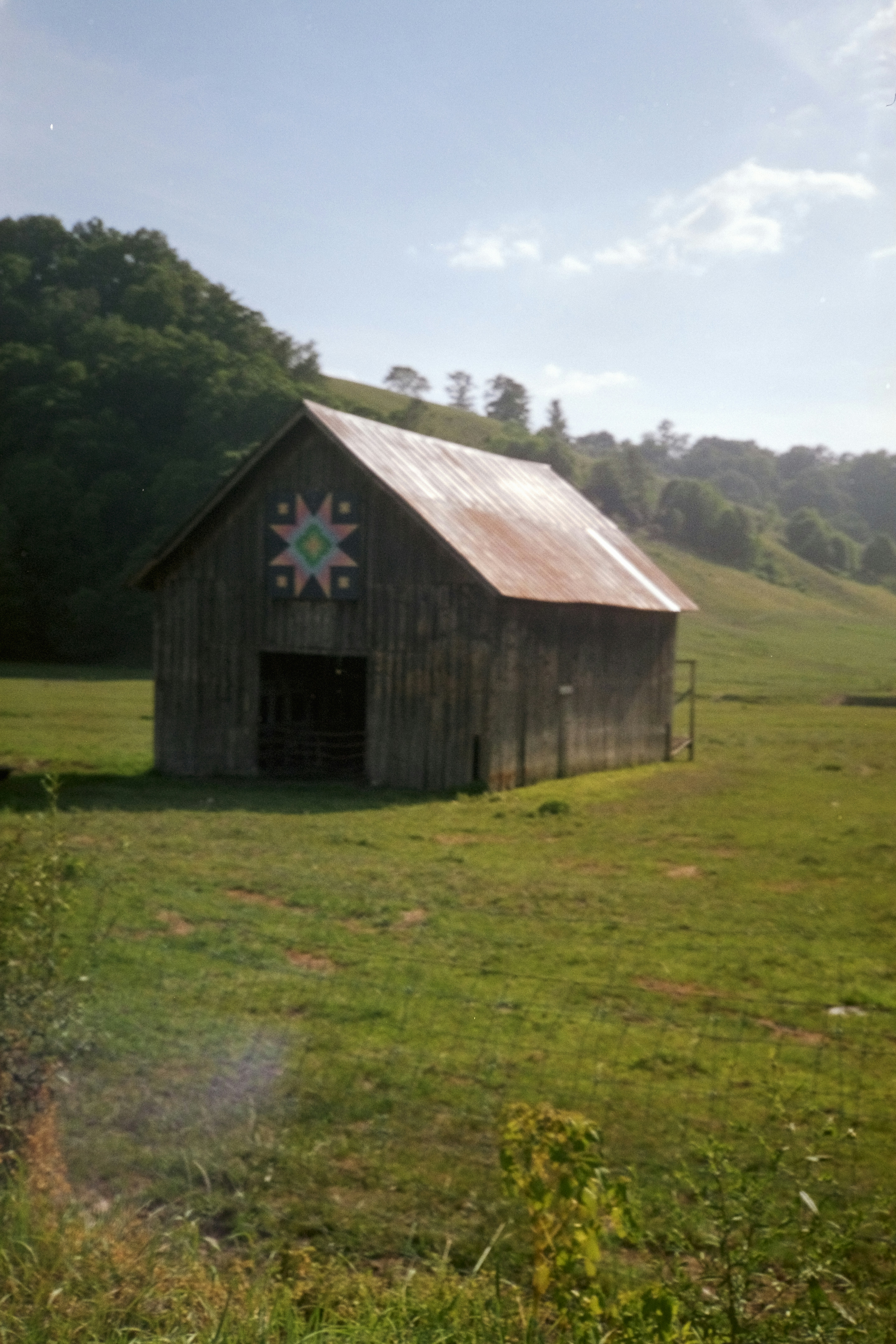 Sunlit Barn on a Quiet Hill