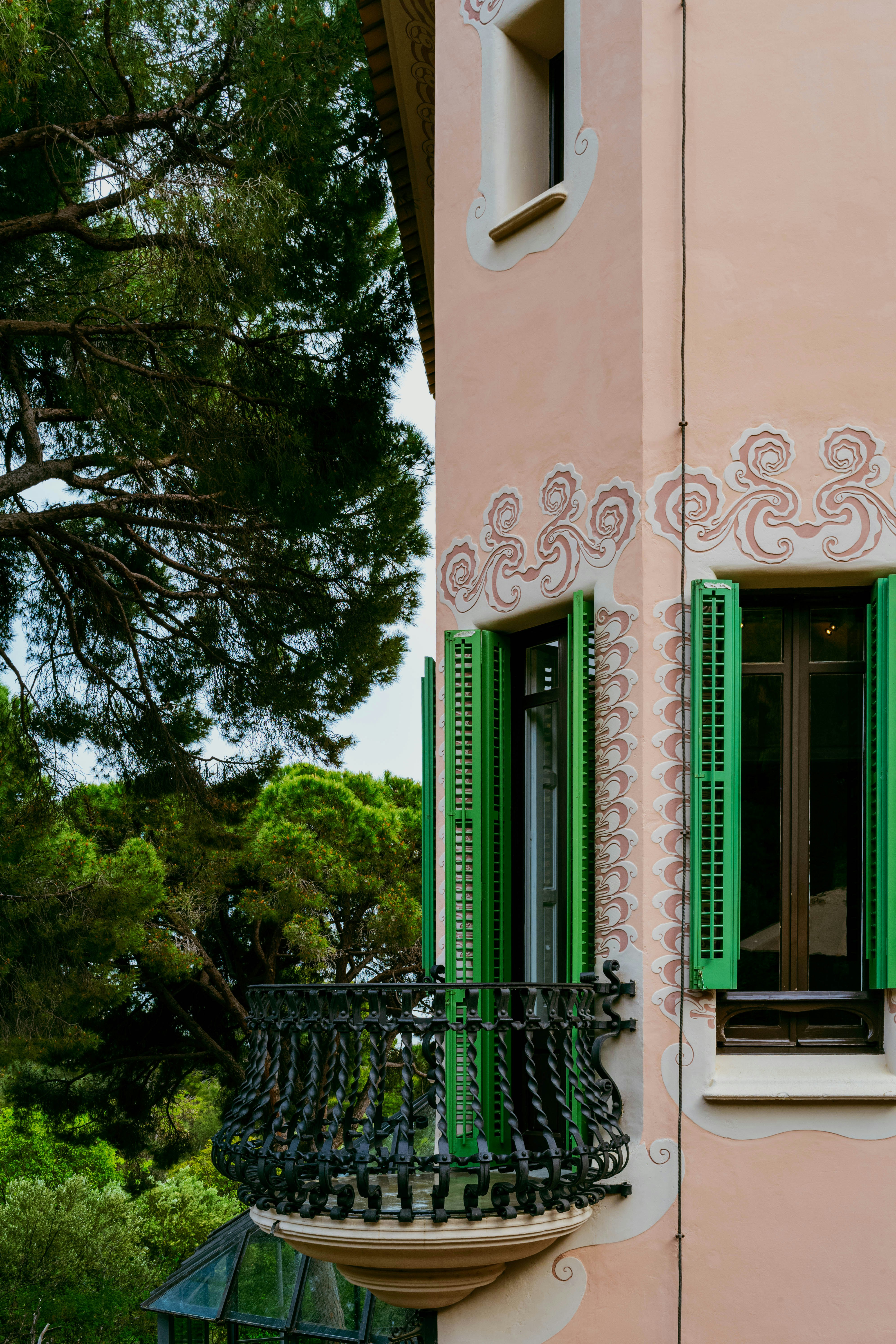 Pastel Facade and Green Shutters: A Quiet Balustrade Moment