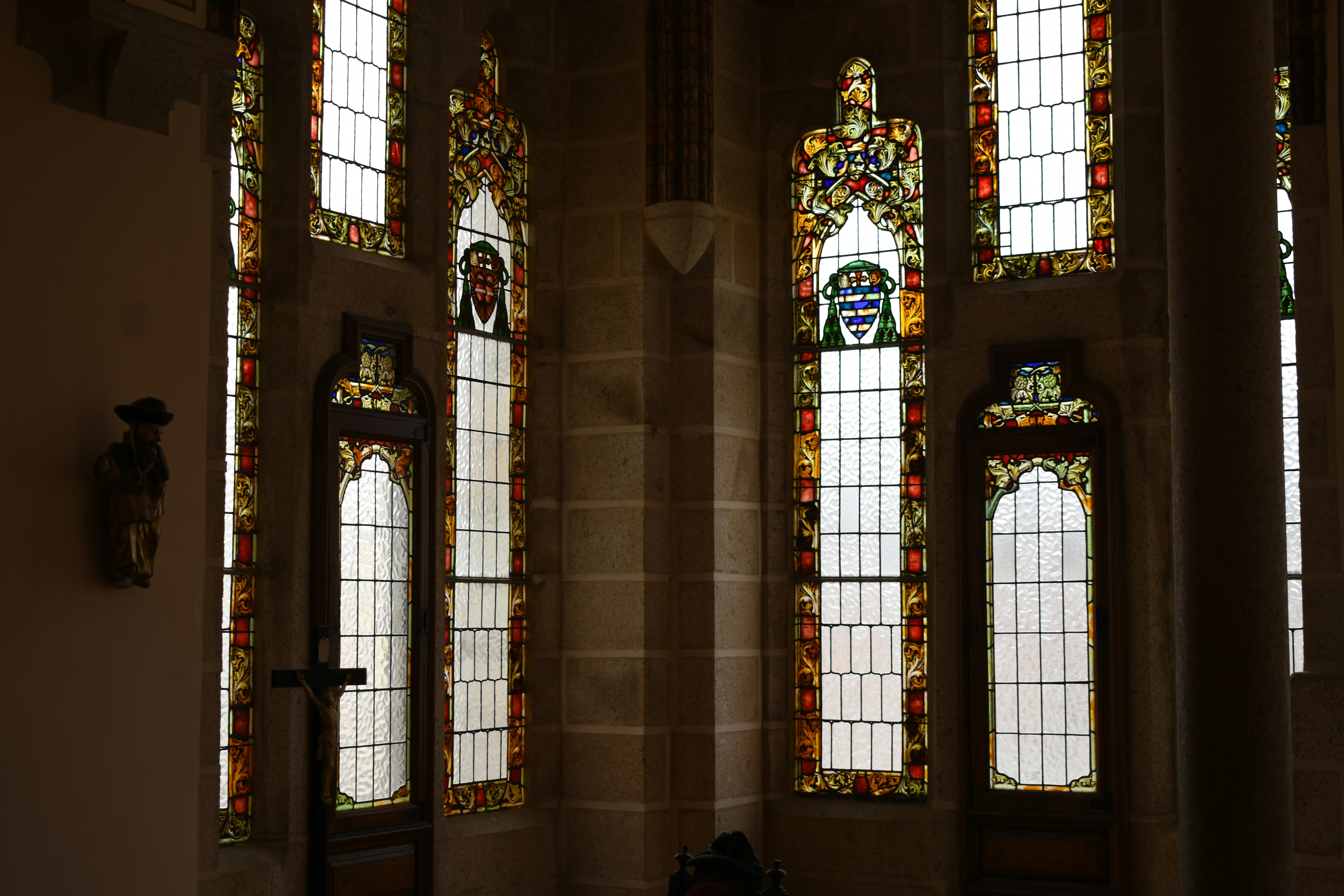 Stained Glass Cathedral Windows Framed by Stone Arches