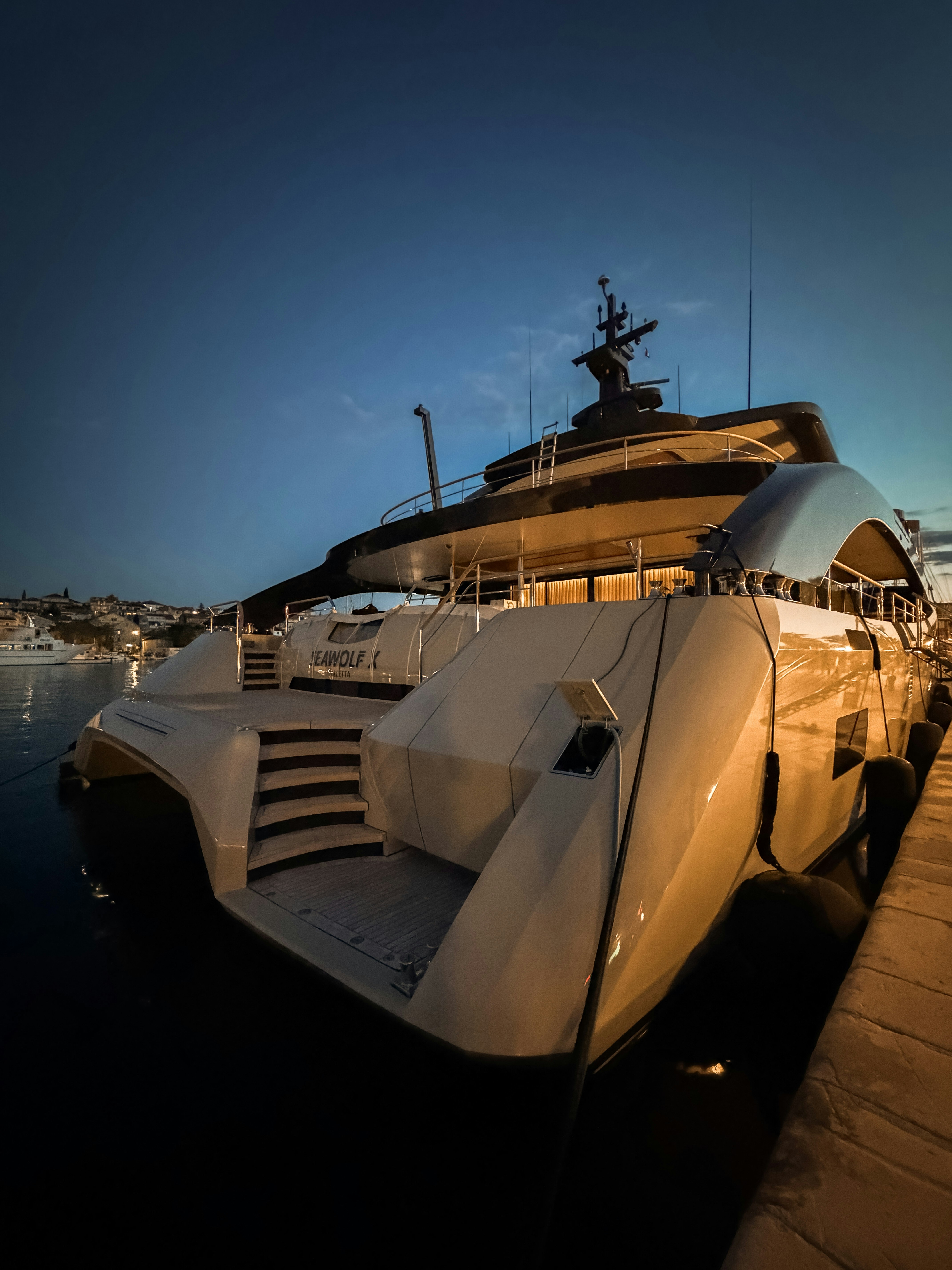Evening Spectacle: A Gleaming Yacht Docked at Quiet Marina