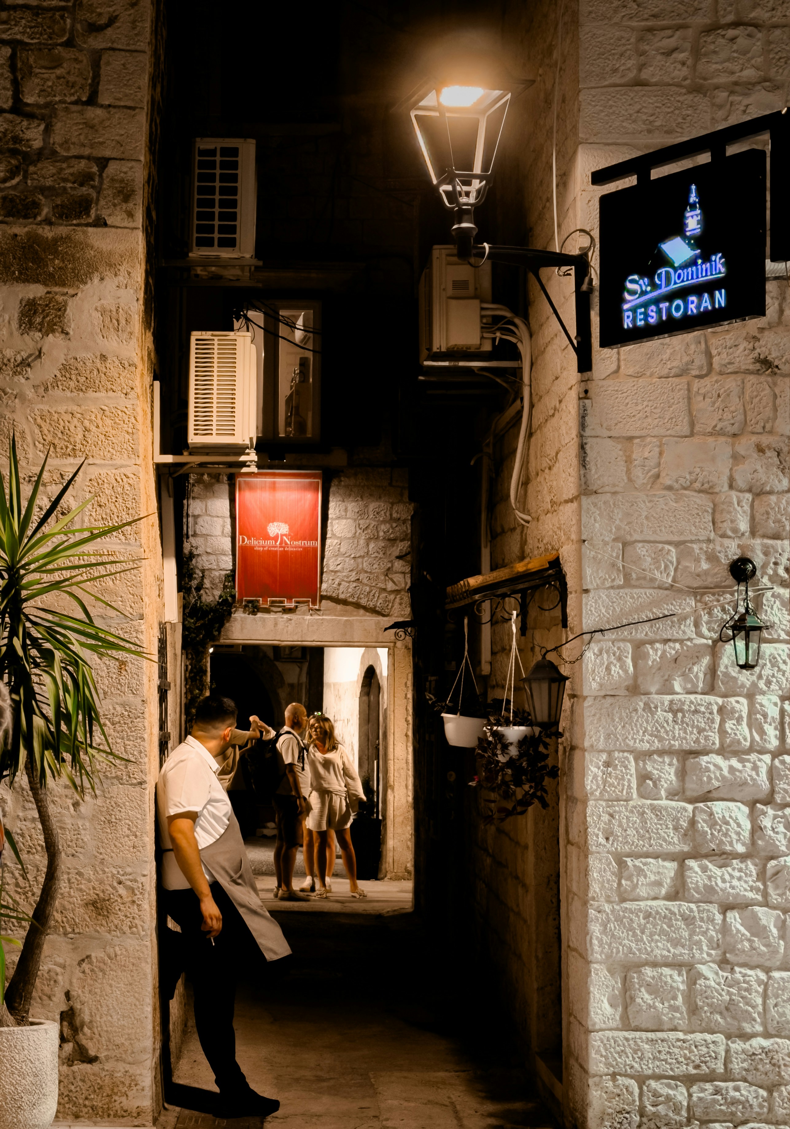 Night Alley in Warm Limestone: Lanterns, Footsteps, and a Hidden Evening Crew