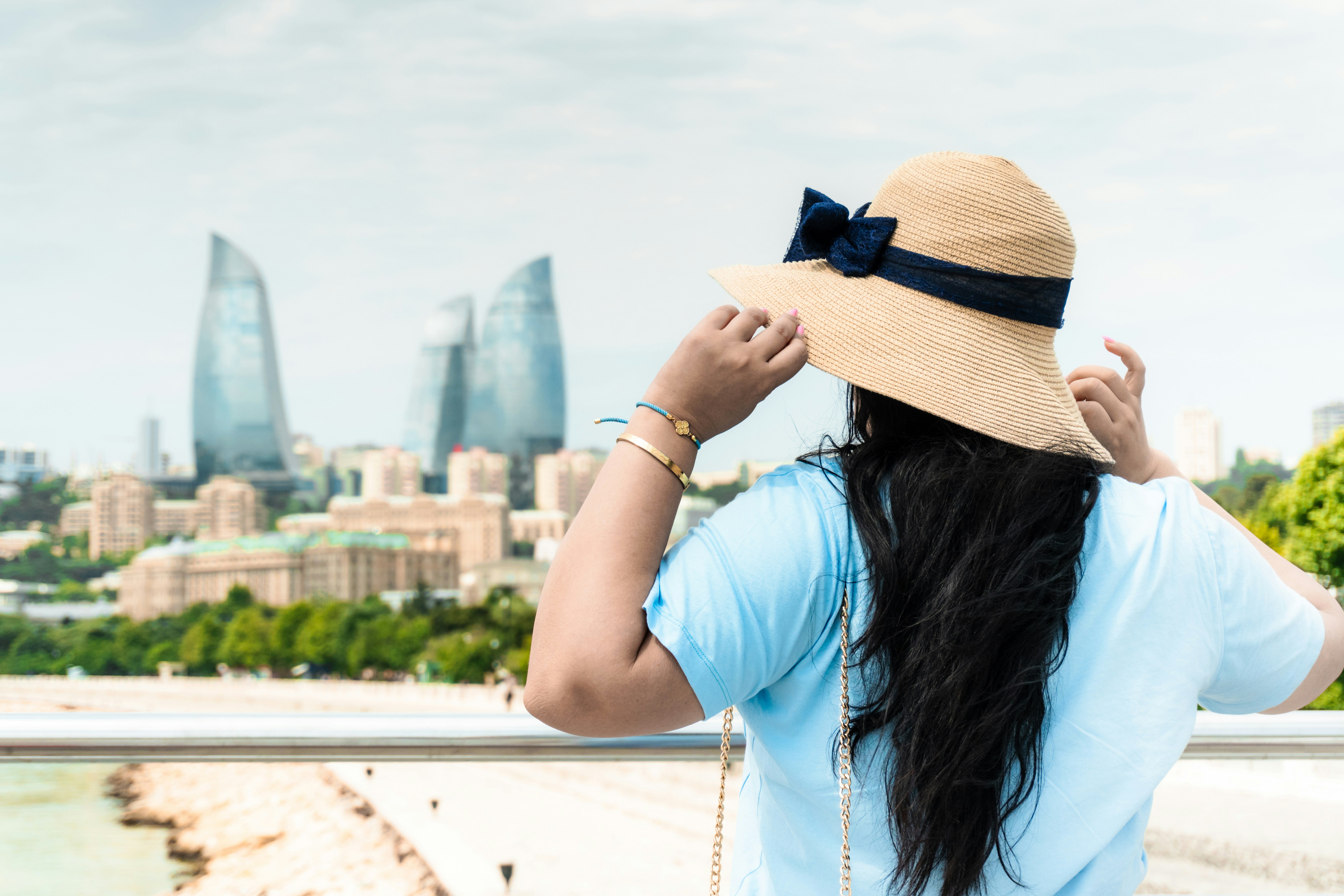 Portrait Over the City: Hat, Hair, and Horizon