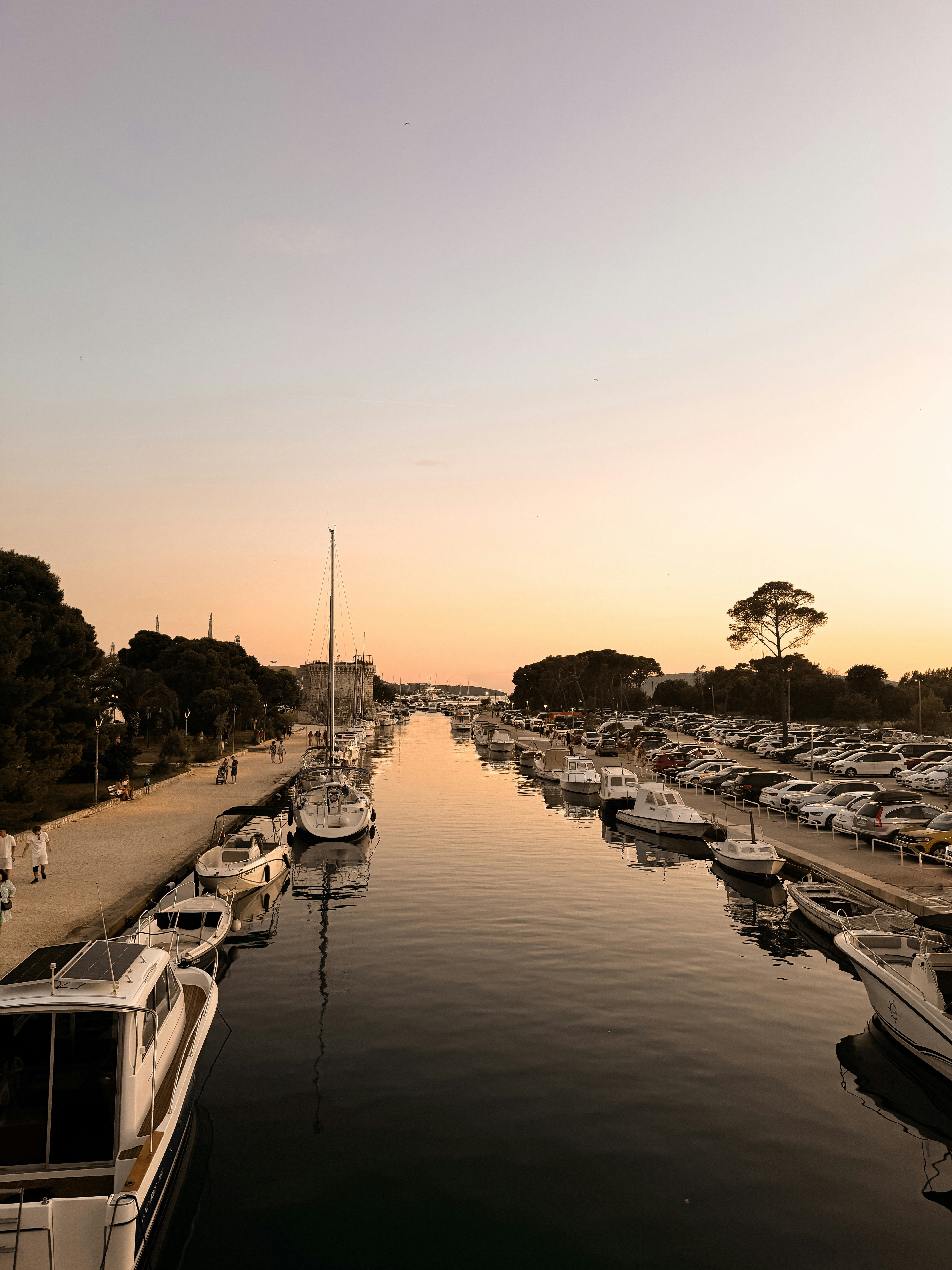 Quiet Marina at Sunset: Boats Lined Along a Calm Channel