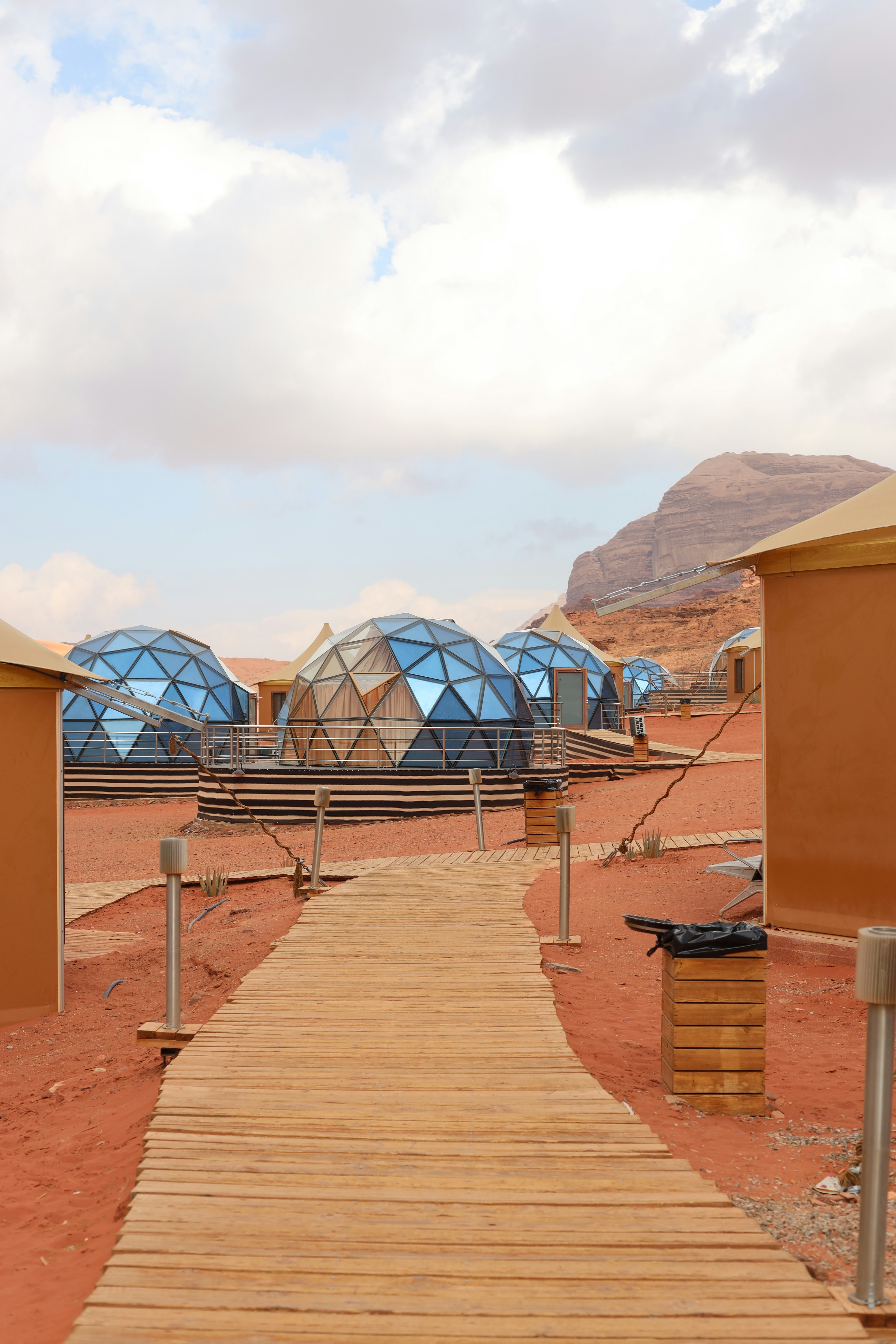 Desert Walkway Toward Geodesic Domes Under a Carved Sky