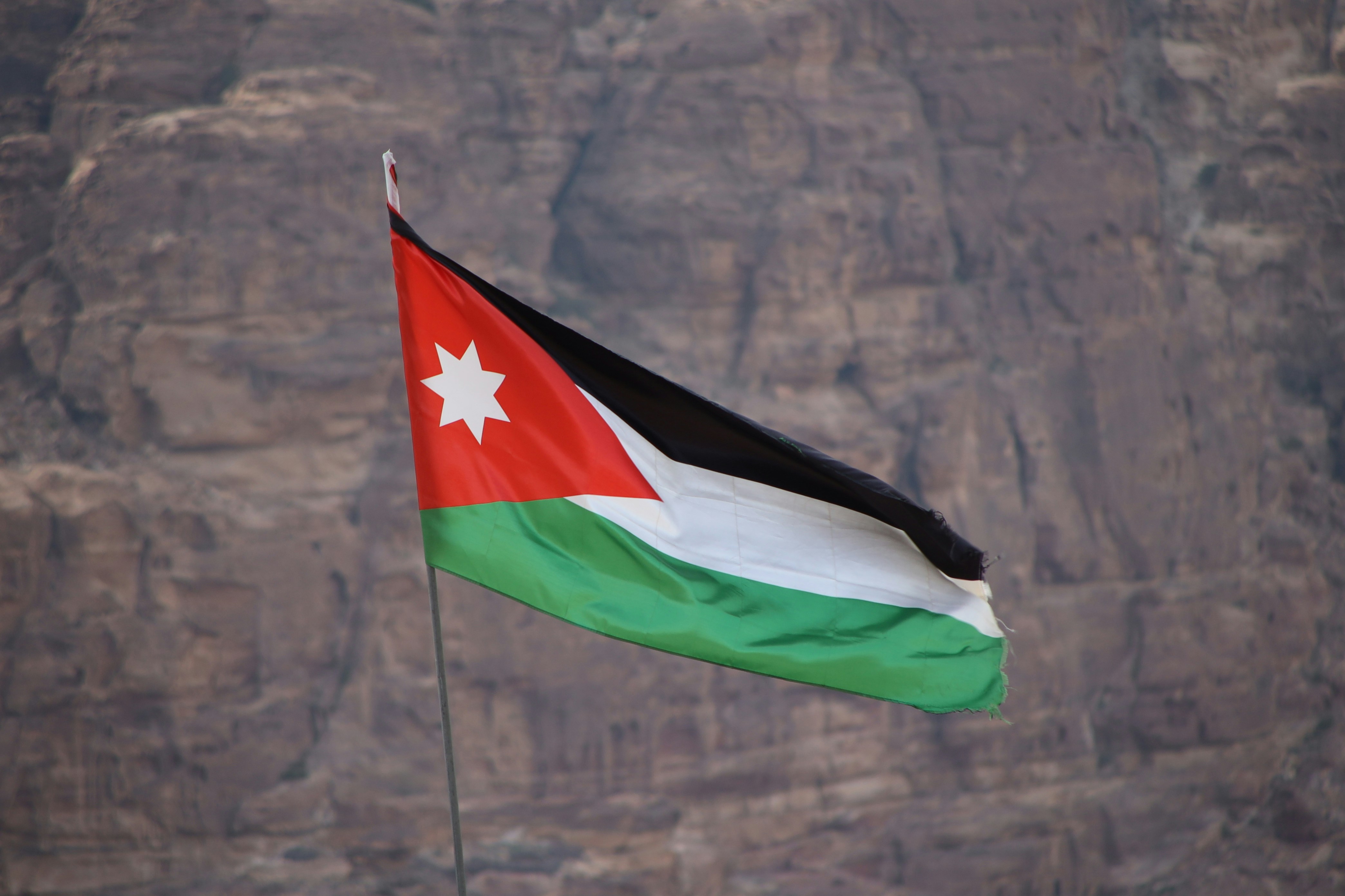 Flag of Jordan in a Wind-Swept Canyon Vista