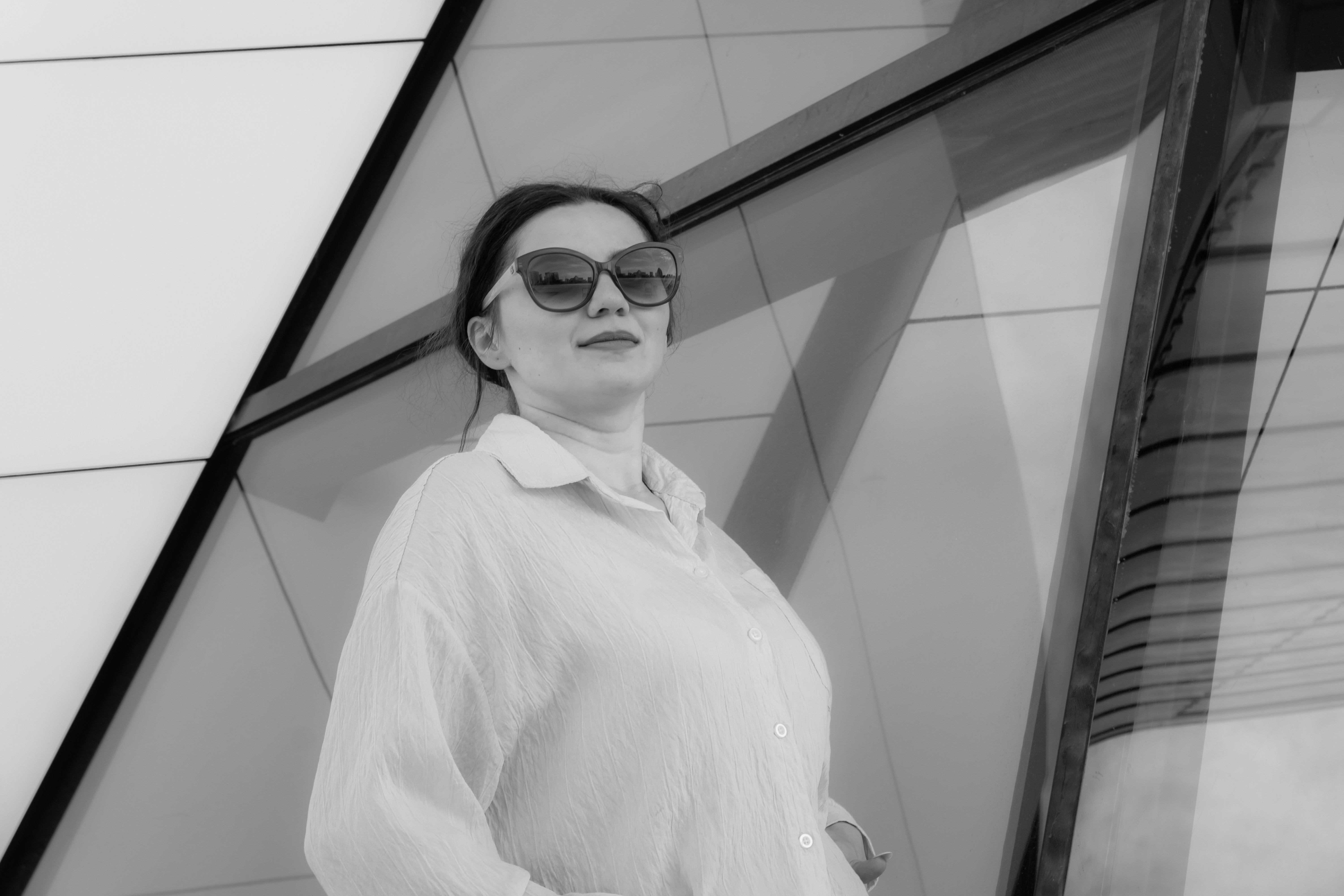 Architectural Portrait: A Confident Silhouette against Glass Facade