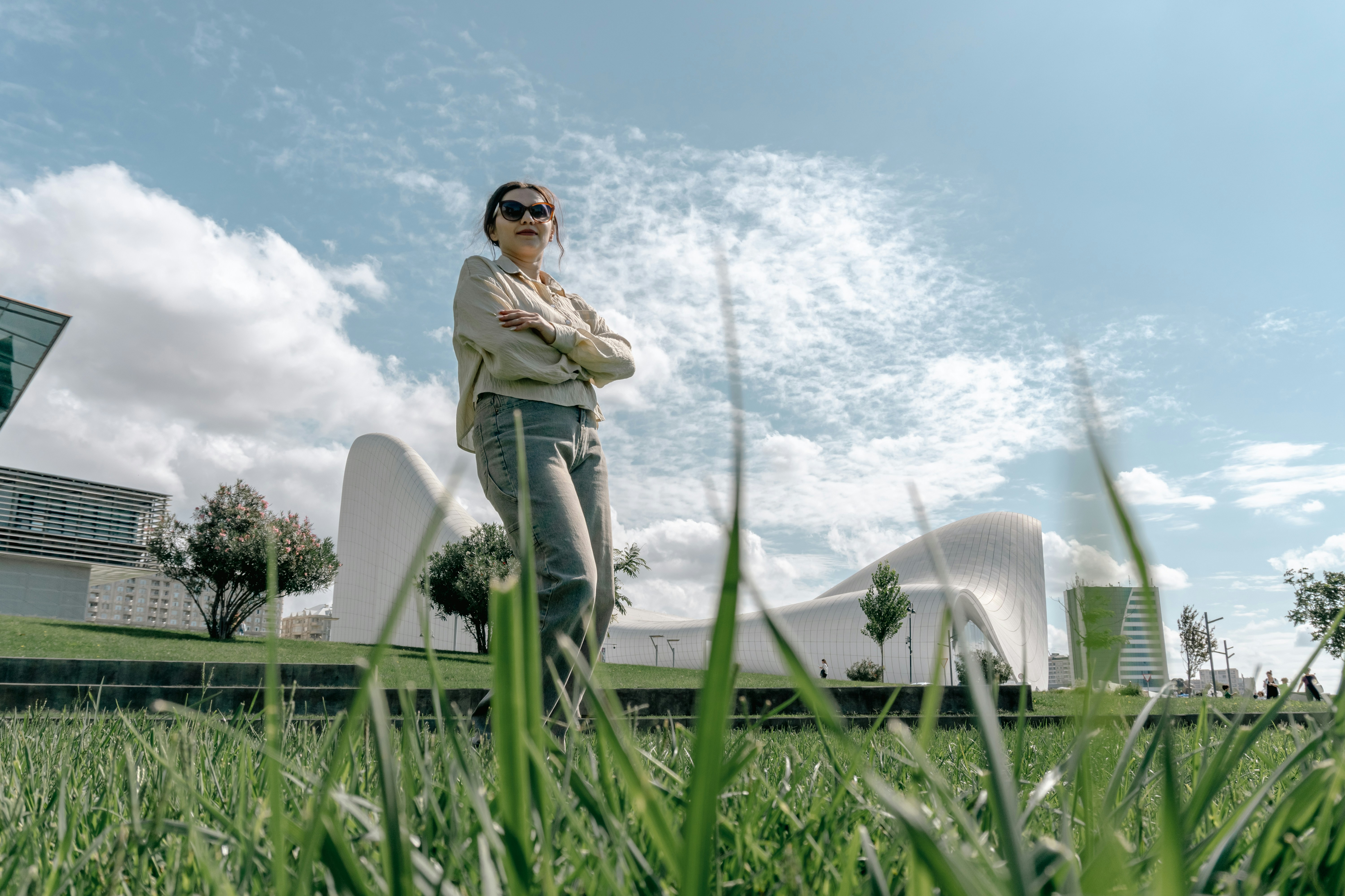 Stature in the Park: A Confident Pose Amid Modern Architecture