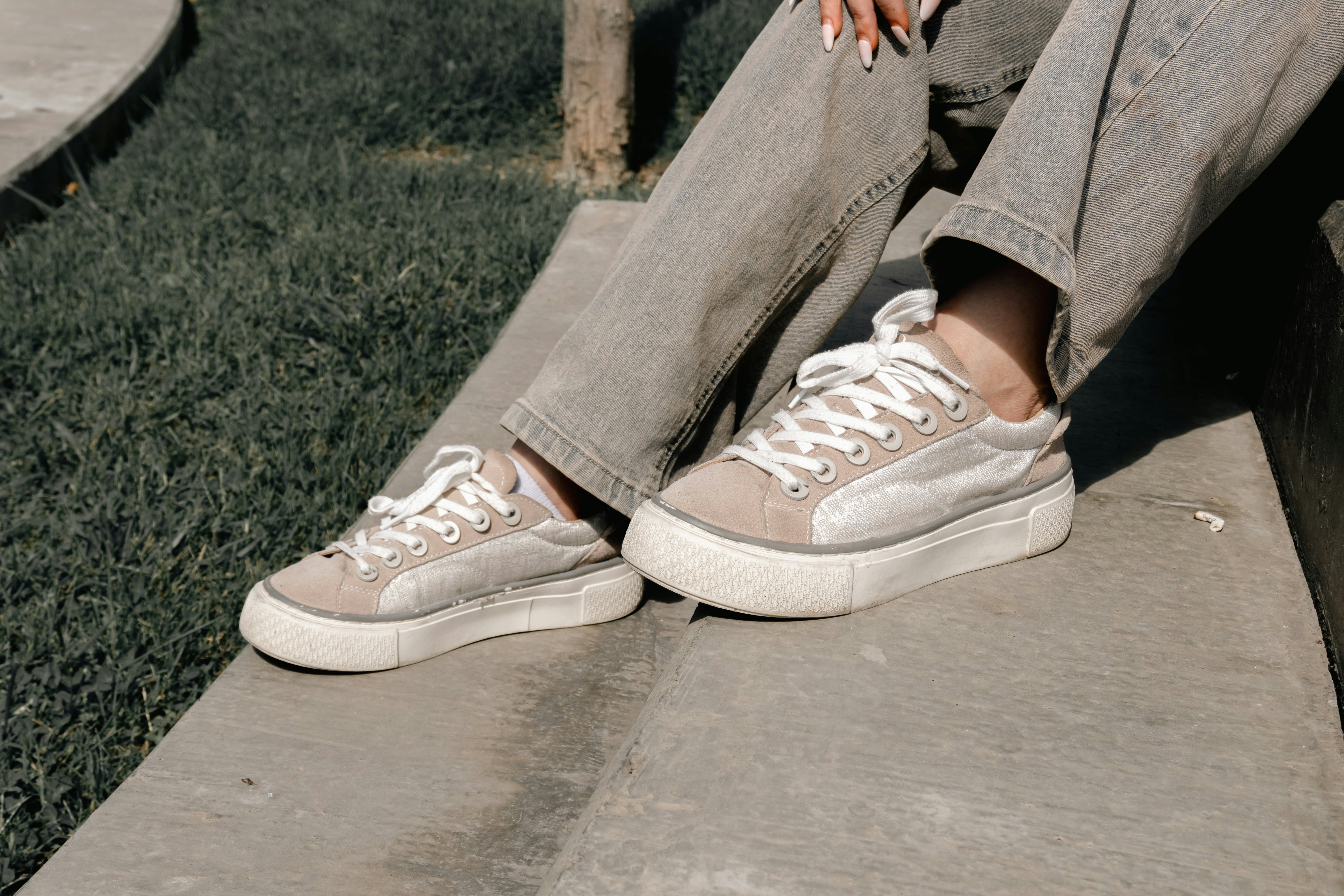 Sneakered Pause: Light Grey Steps and Quiet Jeans