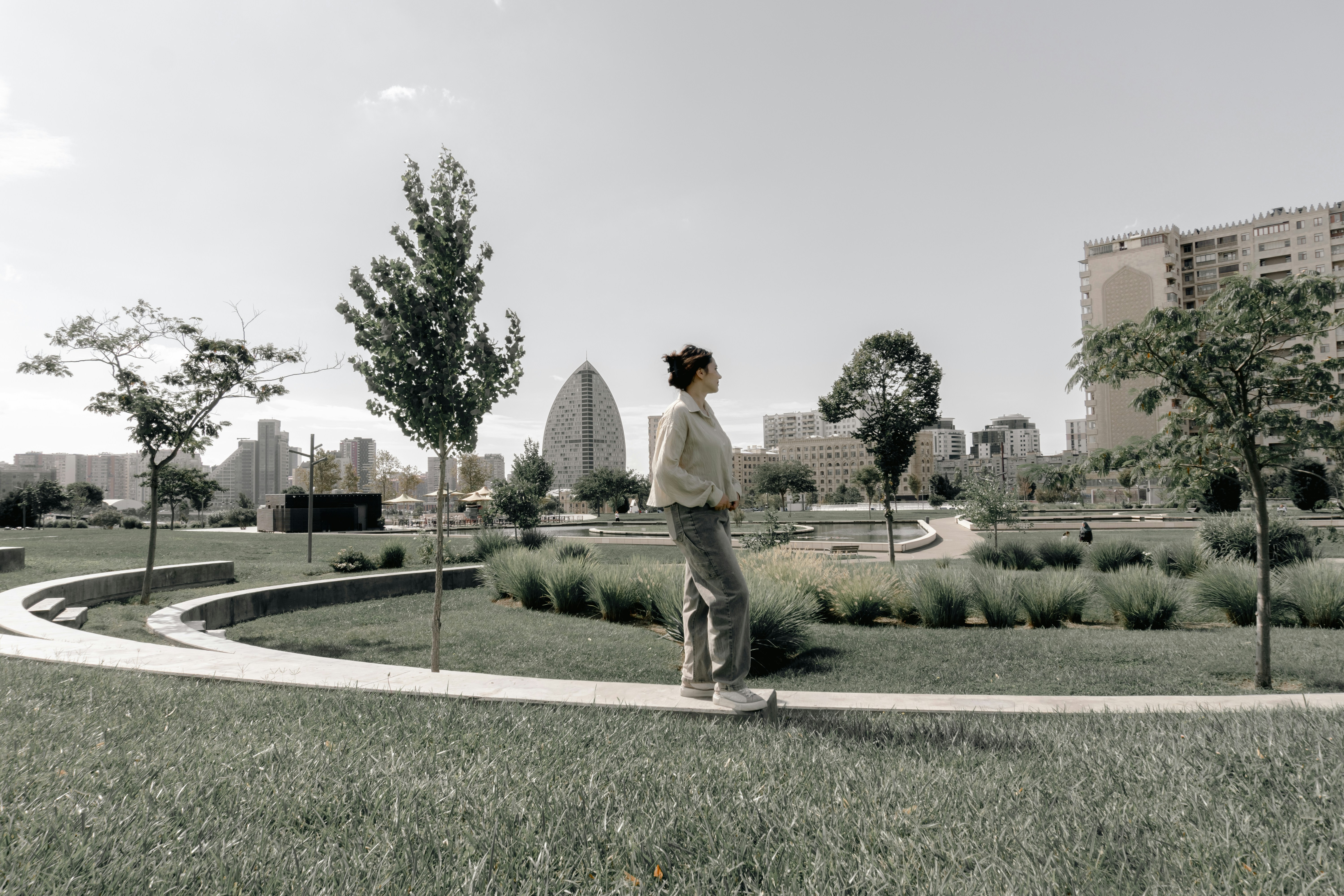 Stillness on the Curve: a lone runner in a modern park