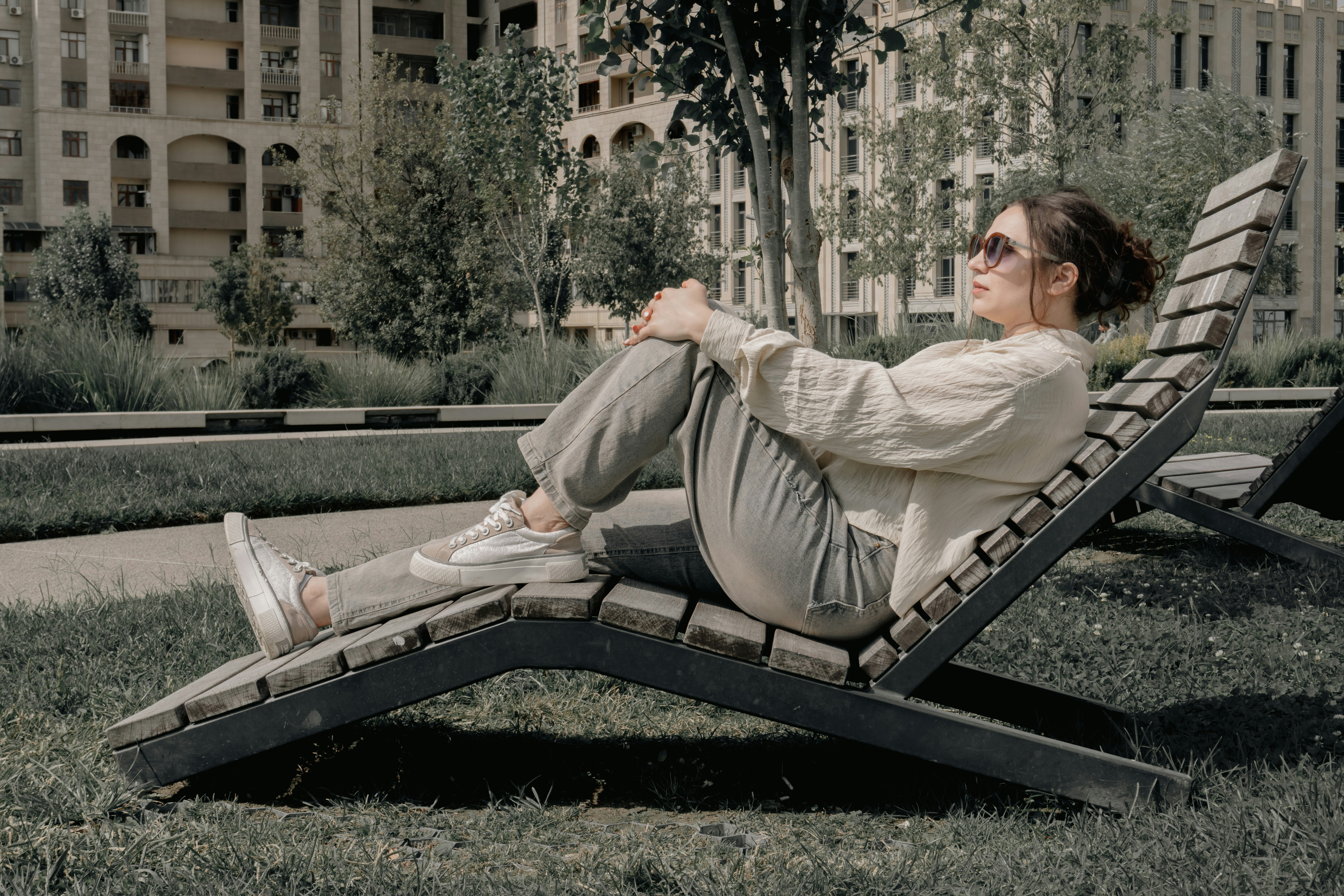 Relaxed Recline: A Sunlit Moment in a Modern Urban Oasis