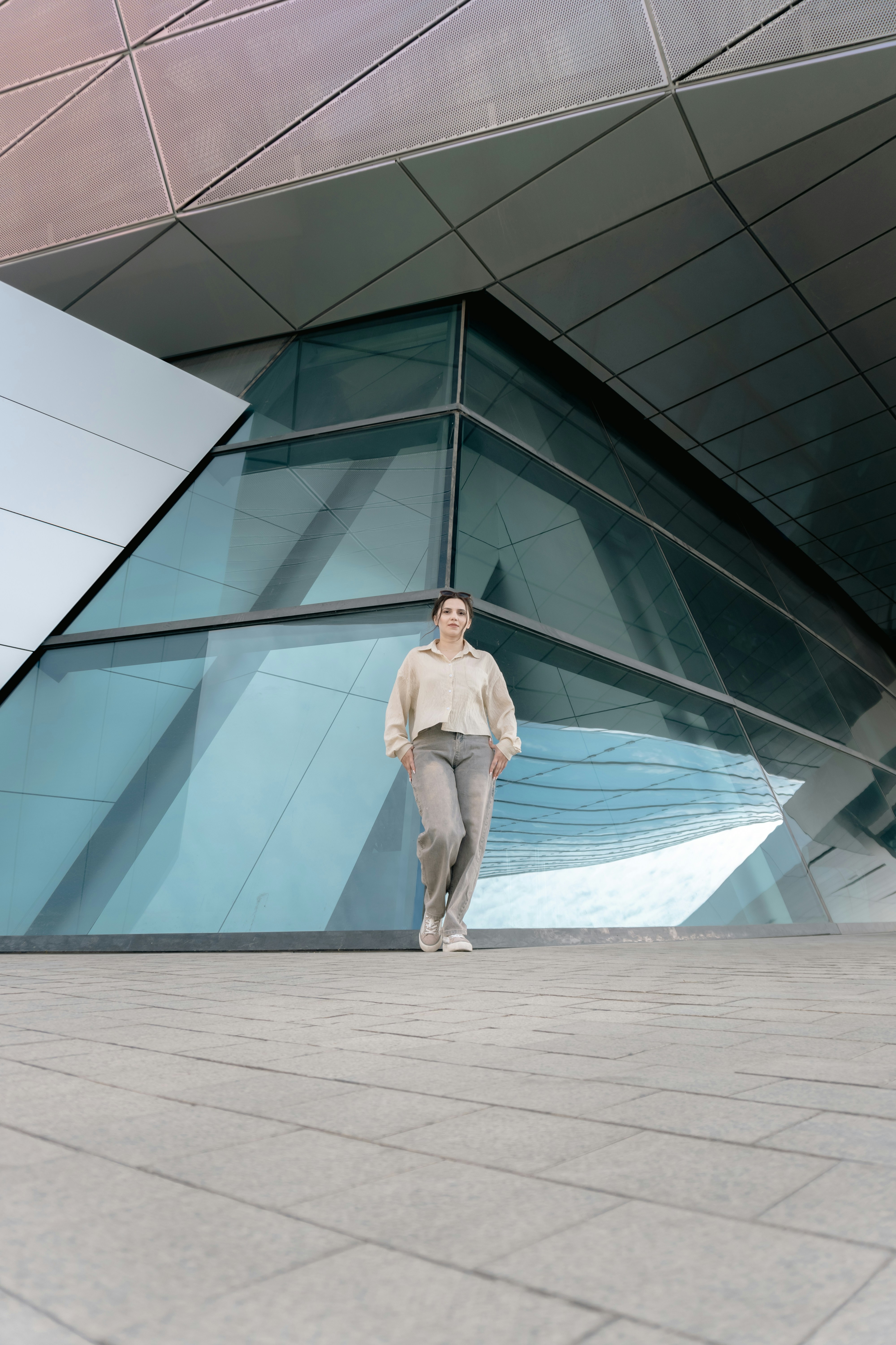 Grounded in Geometry: A Solo Figure in the Glass Facade