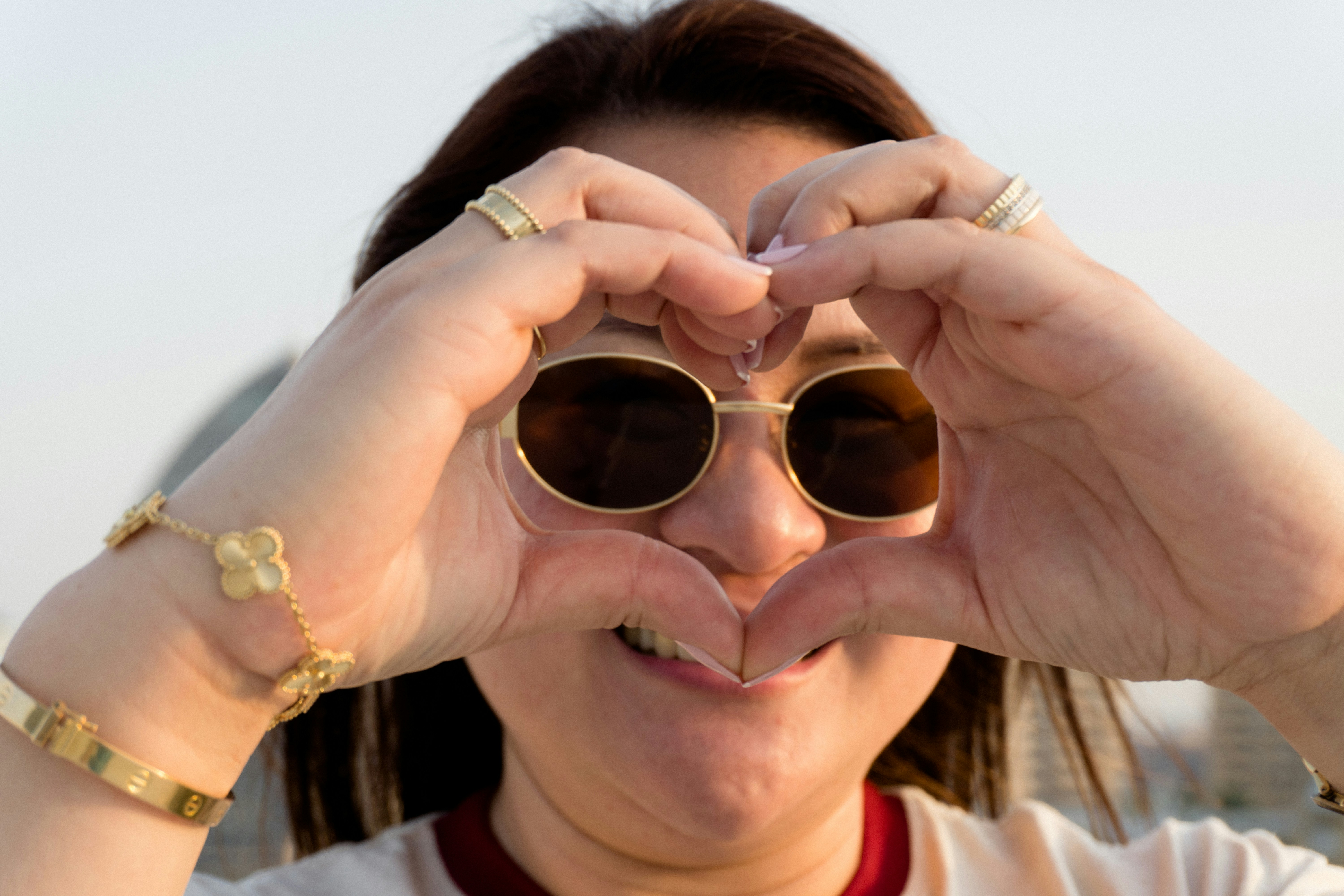 Heart-Shaped View: A Close-Up Front-Frame of a Woman Framing with Hands