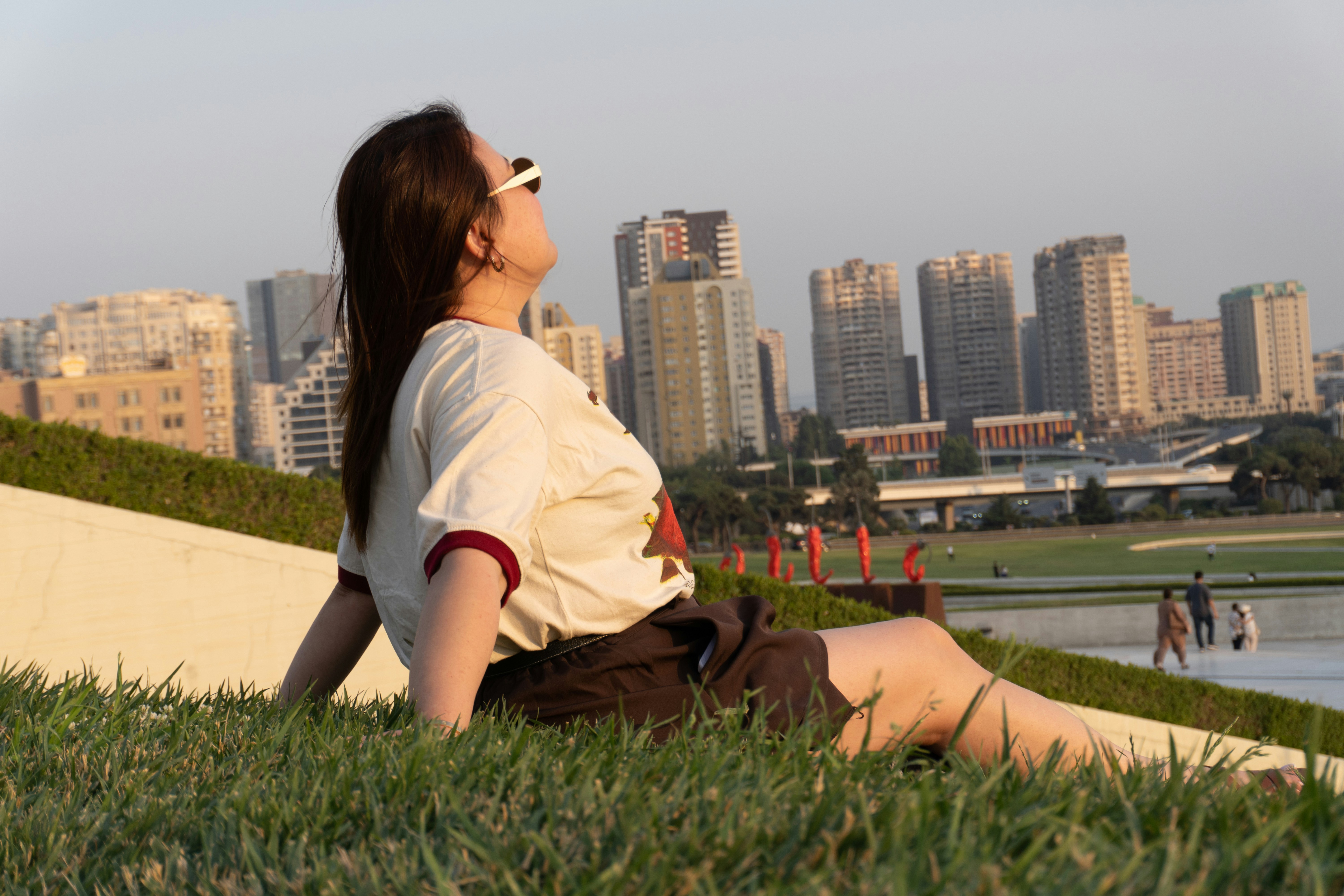 Sunlit Recline: Portrait on a City Grassward