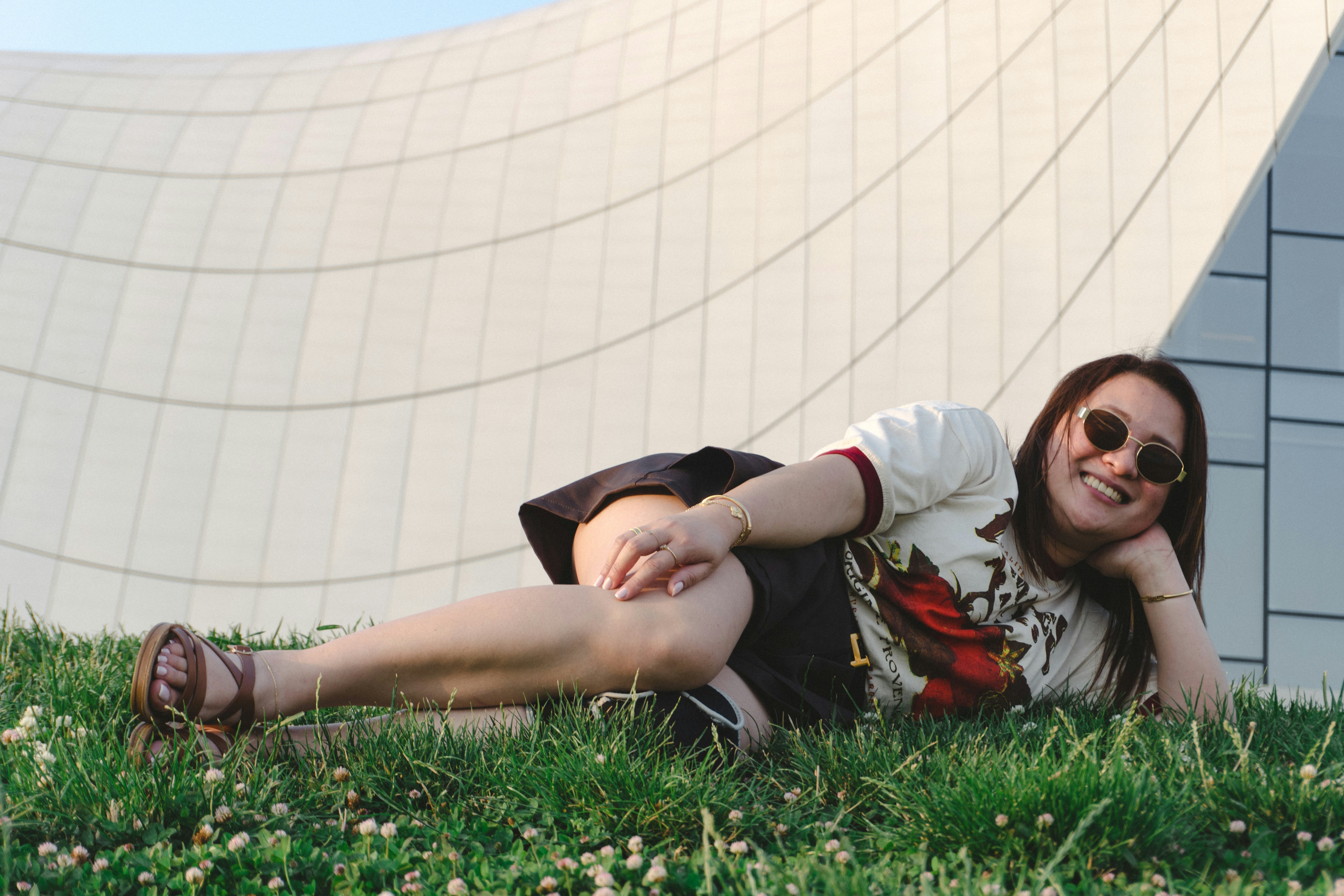 Relaxed portrait on the lawn with modern architectural backdrop