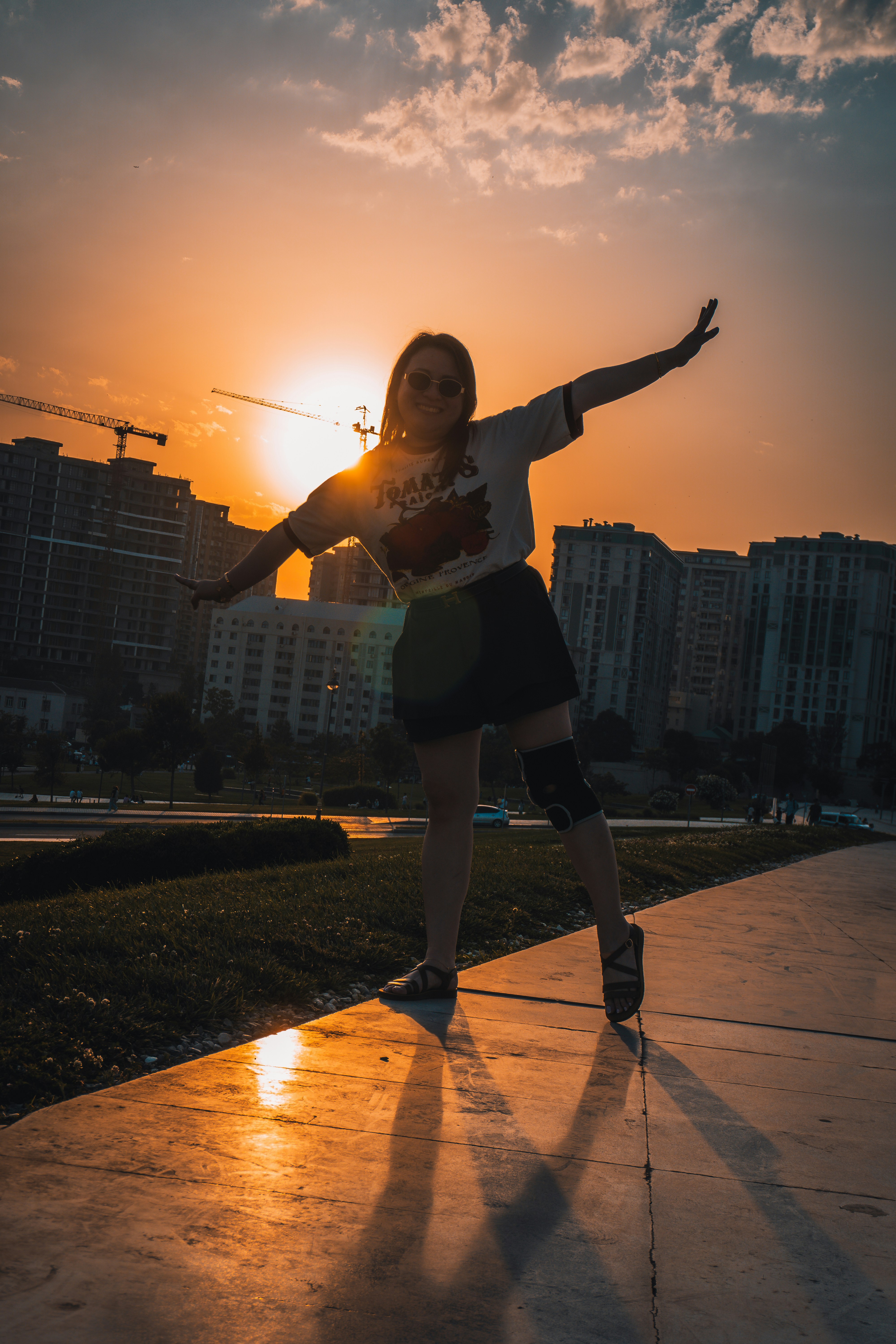Silhouette in Sunset: A Free-spirited Balance on the Urban Path