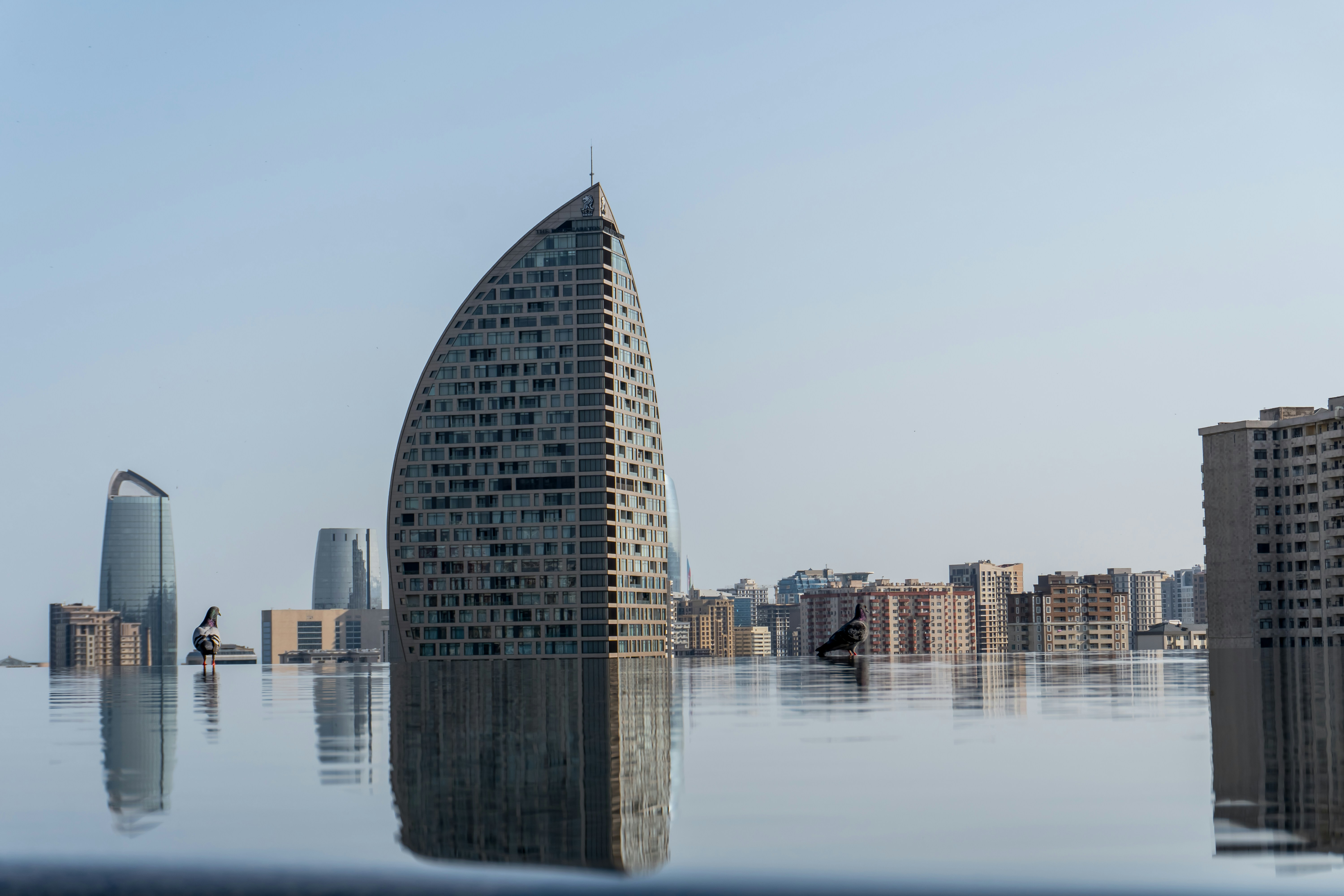 Floating City Sentinel: Building Emerging from a Calm Waterfront