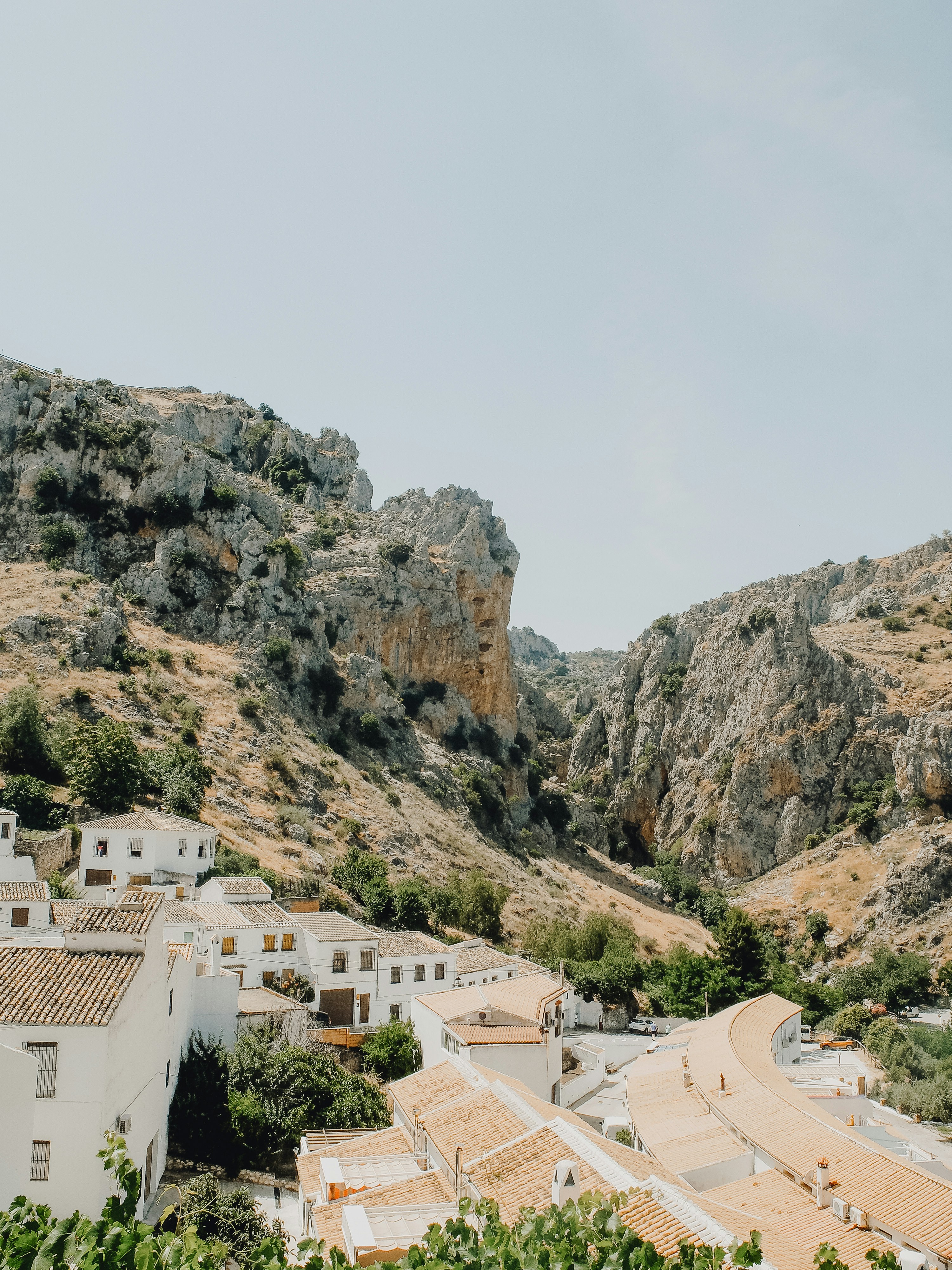 White-washed village tucked beneath rugged cliffs