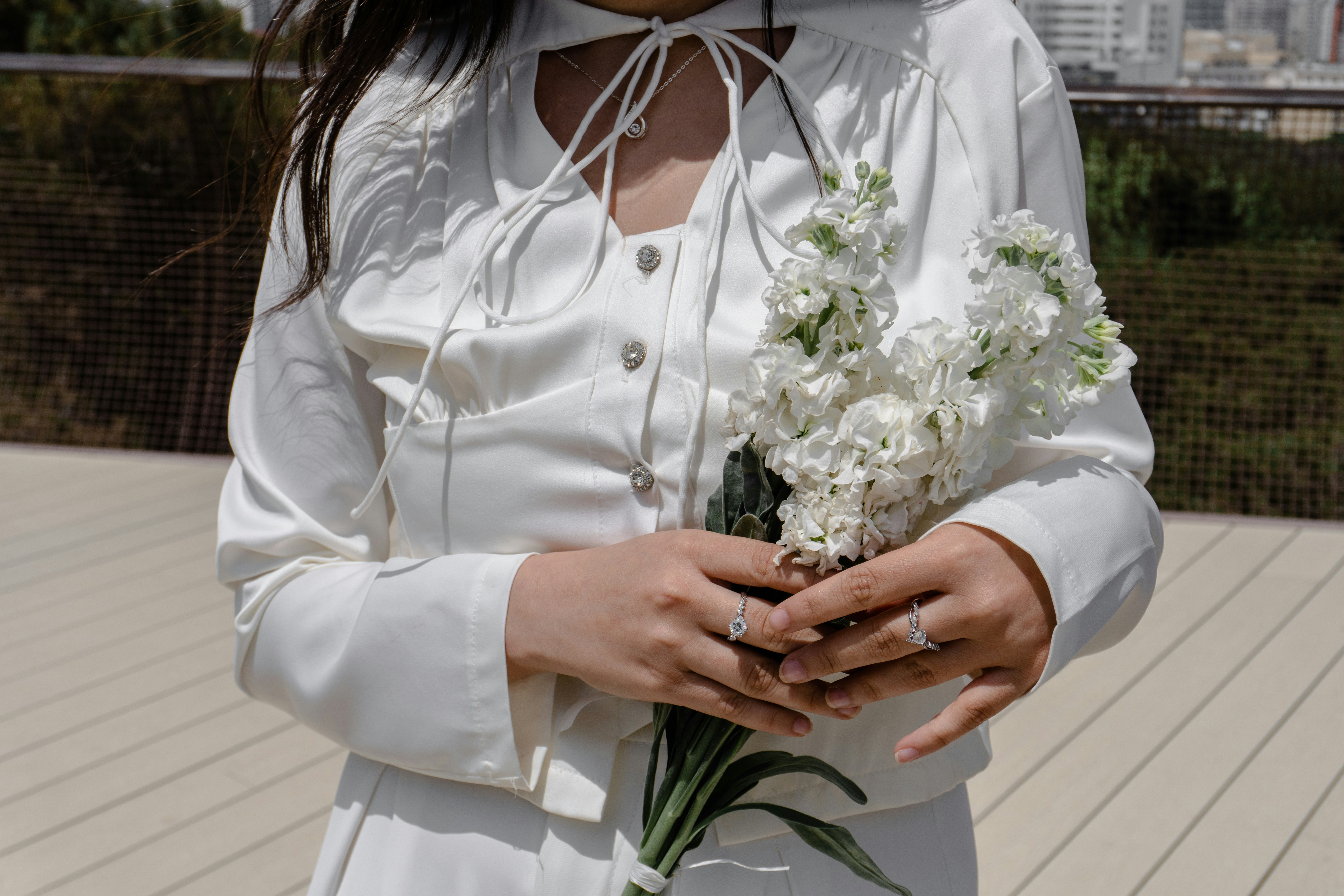 White Bouquet, Quiet Hands: A Bridal Moment on a Sunny Deck
