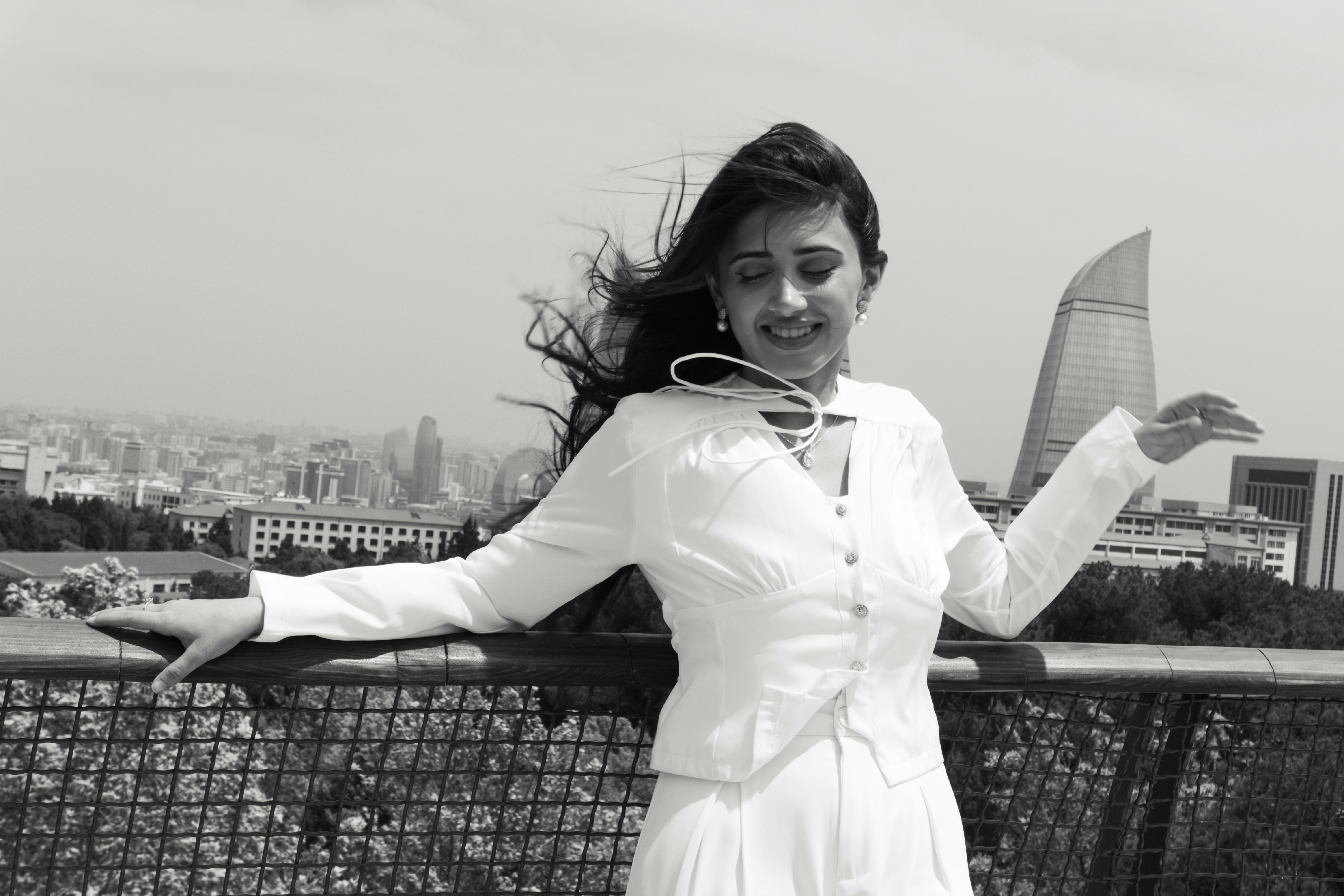 Portrait on a Skyline Balcony: Wind in White