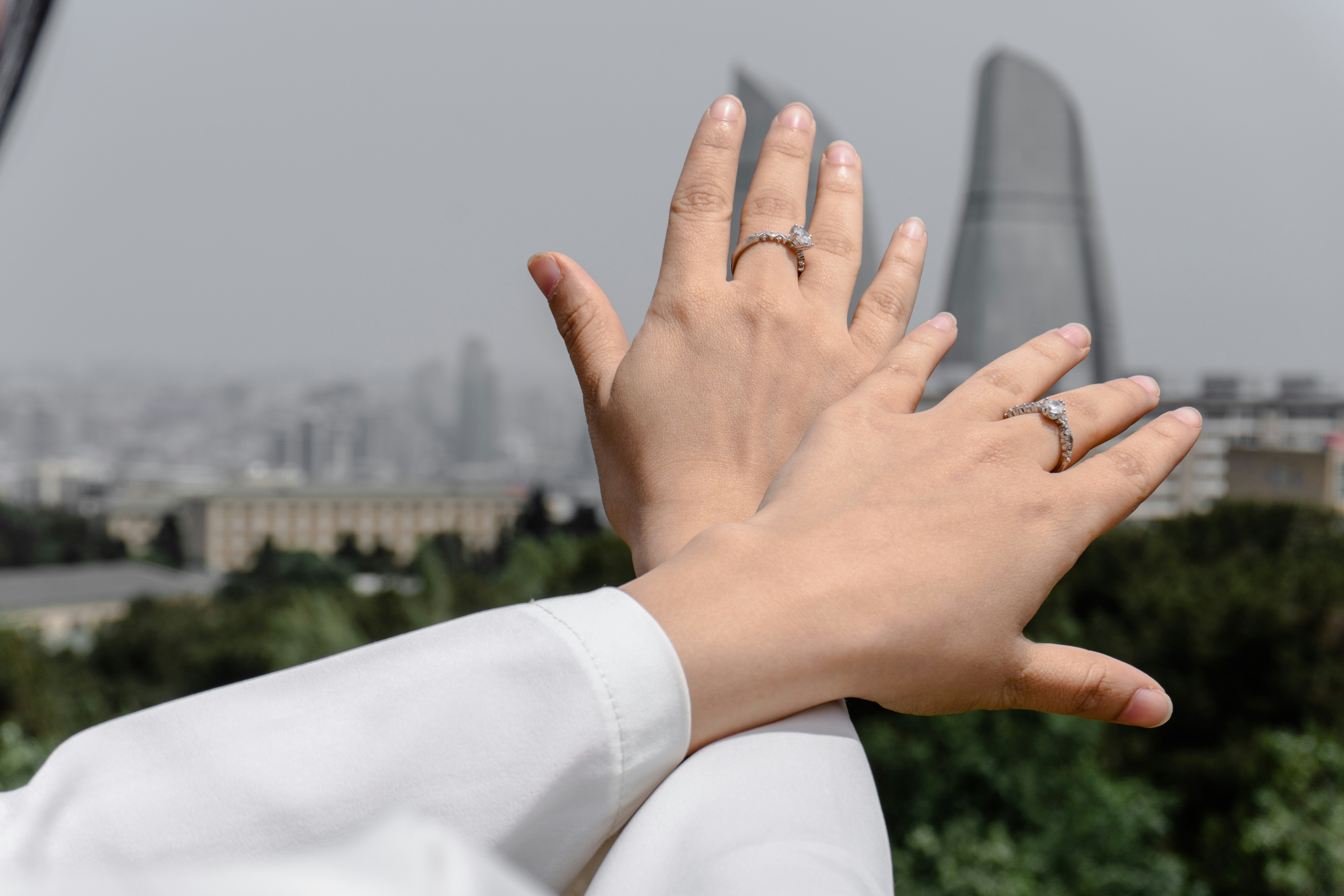 Overlapped Hands Against a Cityscape