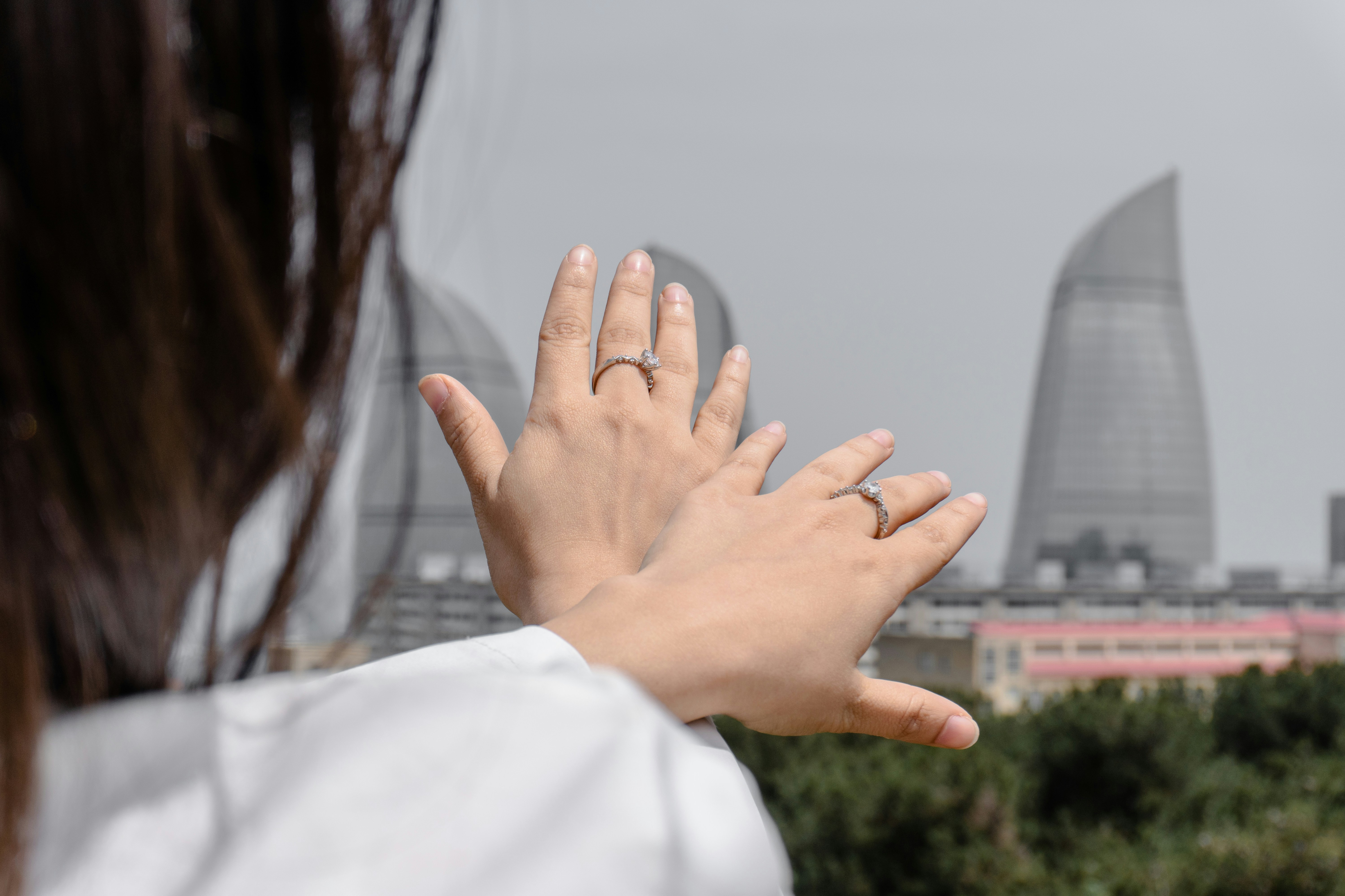 Hands Against the City Horizon: Framed by Urban Silhouettes