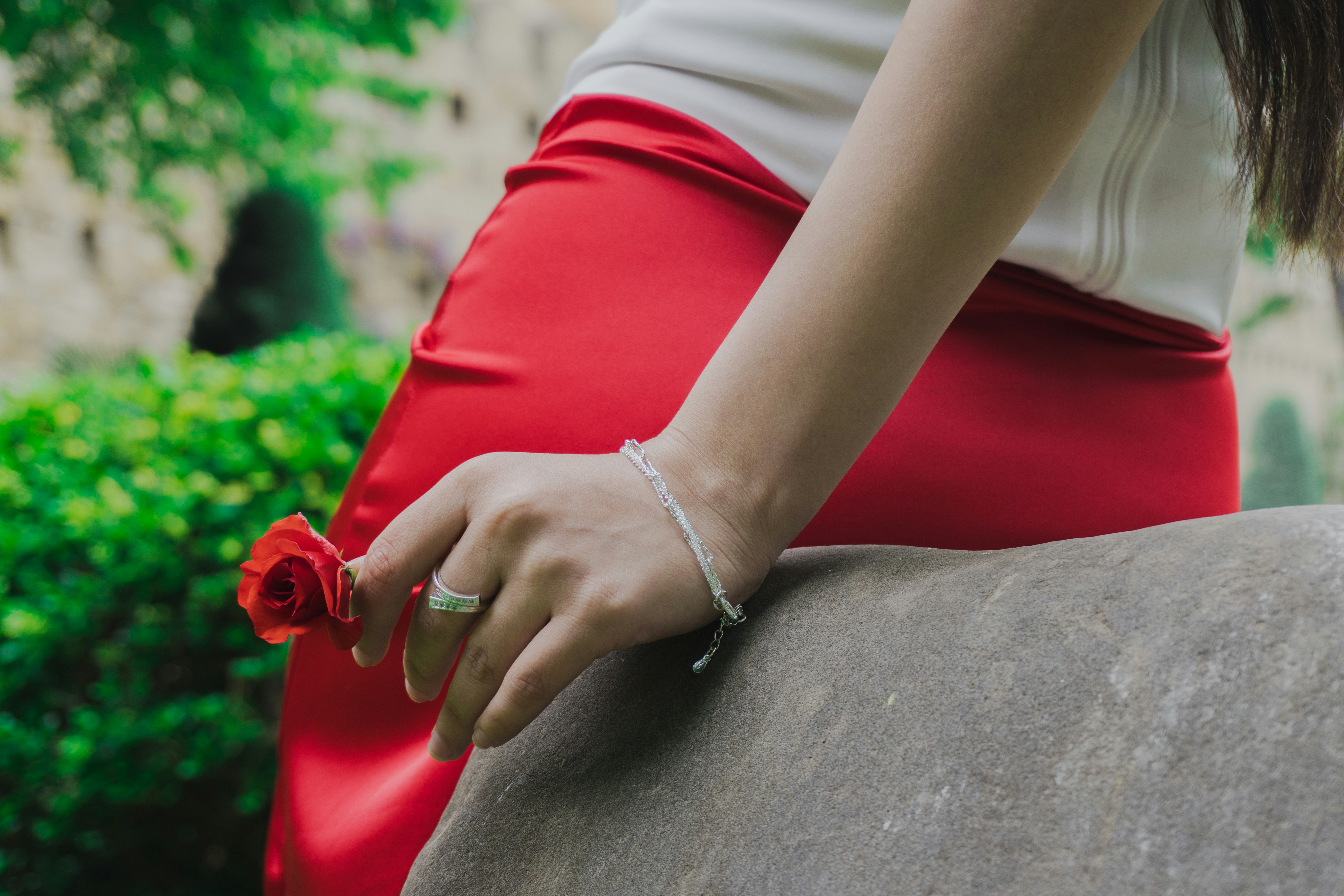 A Quiet Red Moment: A Woman in a Velvet Red Skirt and Delicate Ring