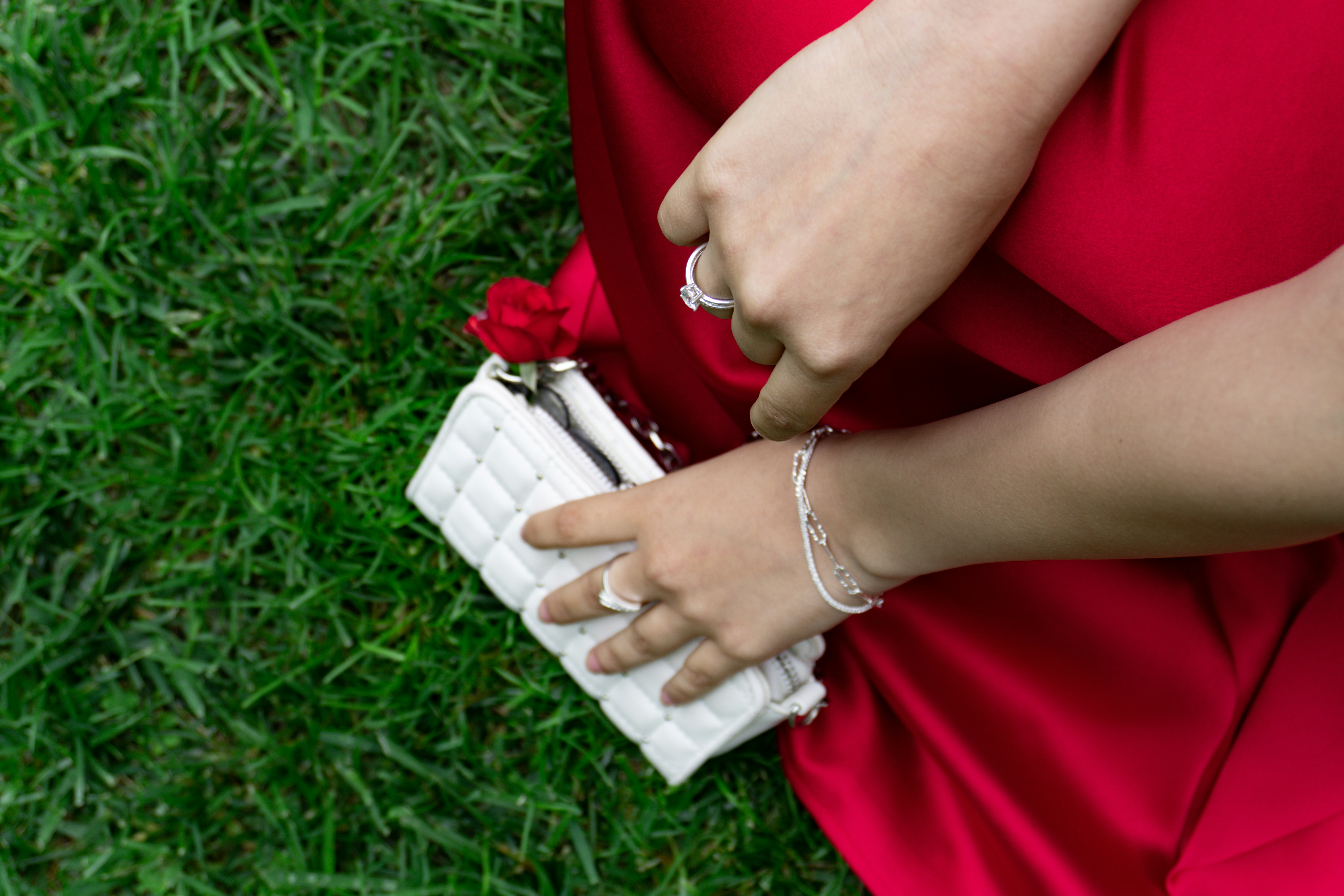Crimson Fabric and White Lace: A Quiet Moment on Grass