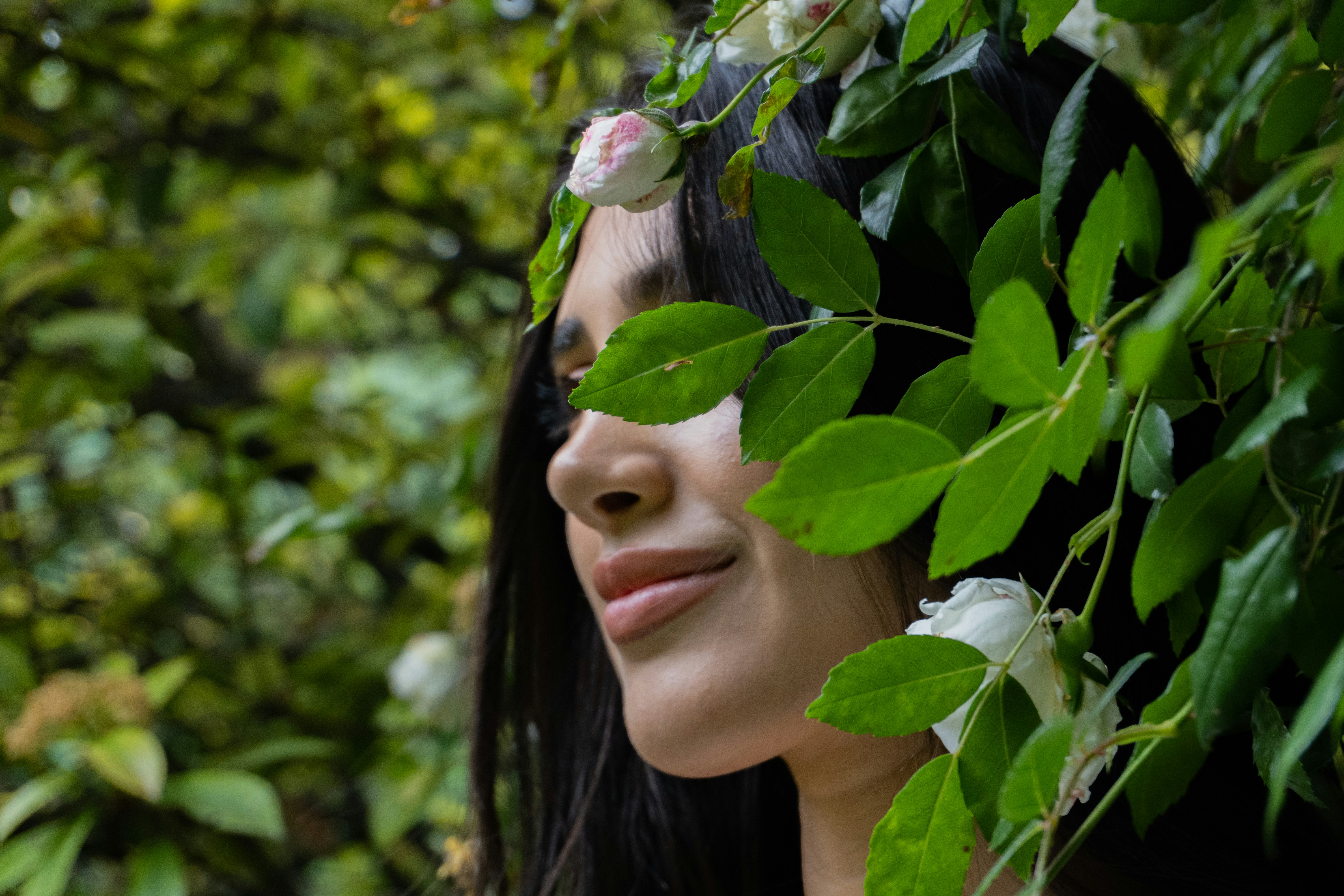 Hidden Smile: A Portrait Framed by Leaves